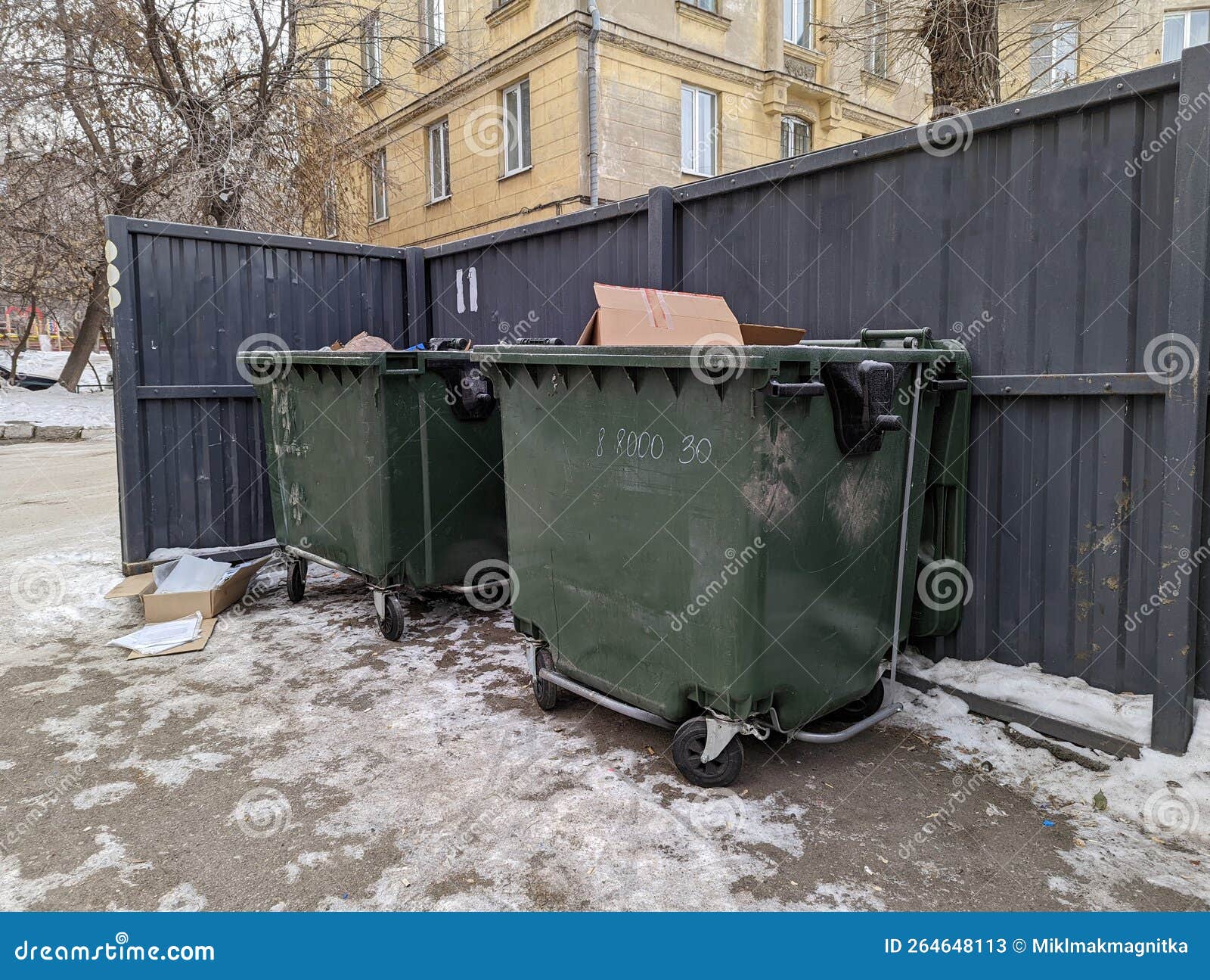 Green Plastic Containers for Garbage Collection in the Yard of an Old ...