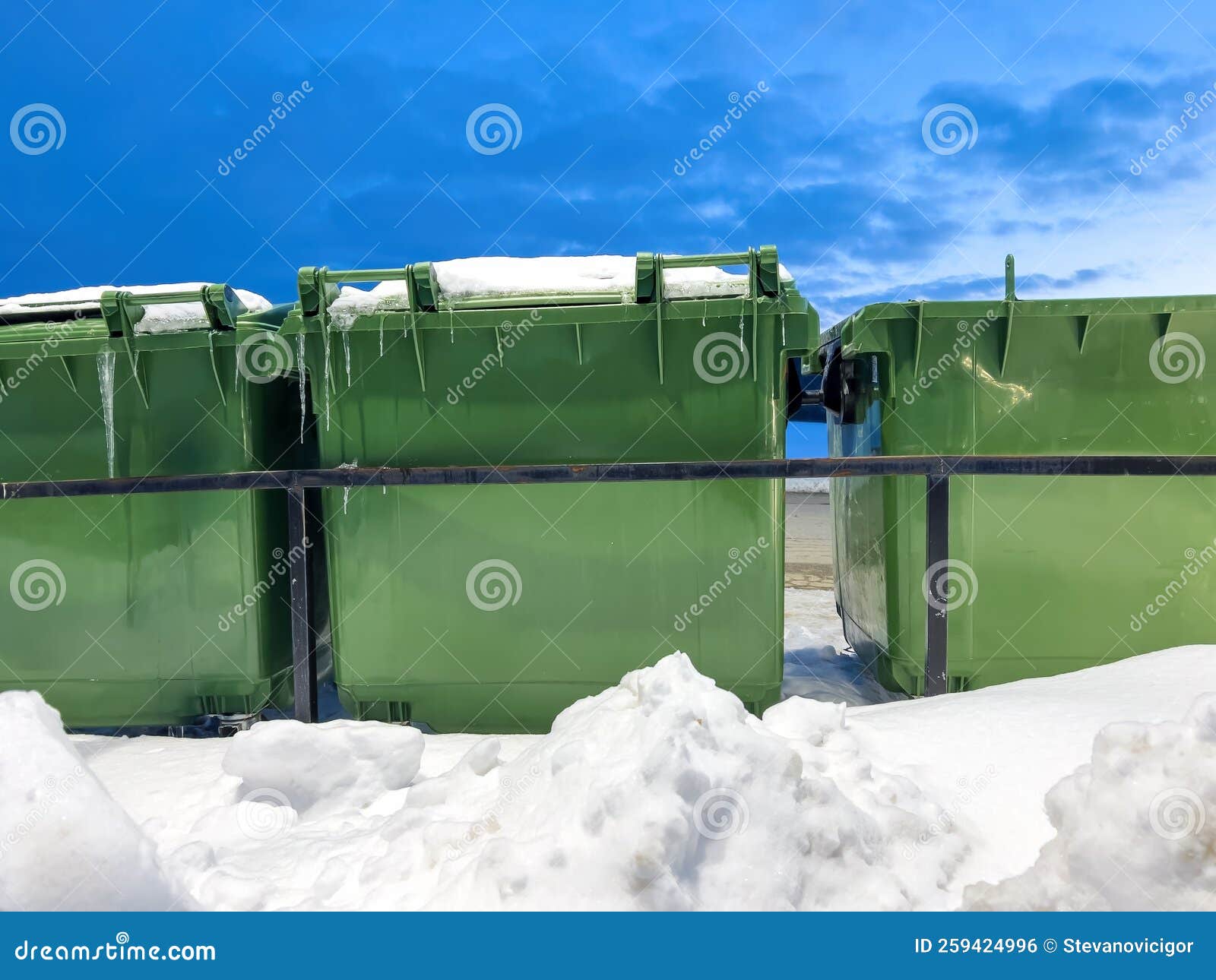 Green Plastic Dumpster or Waste and Garbage Containers in Snow in ...