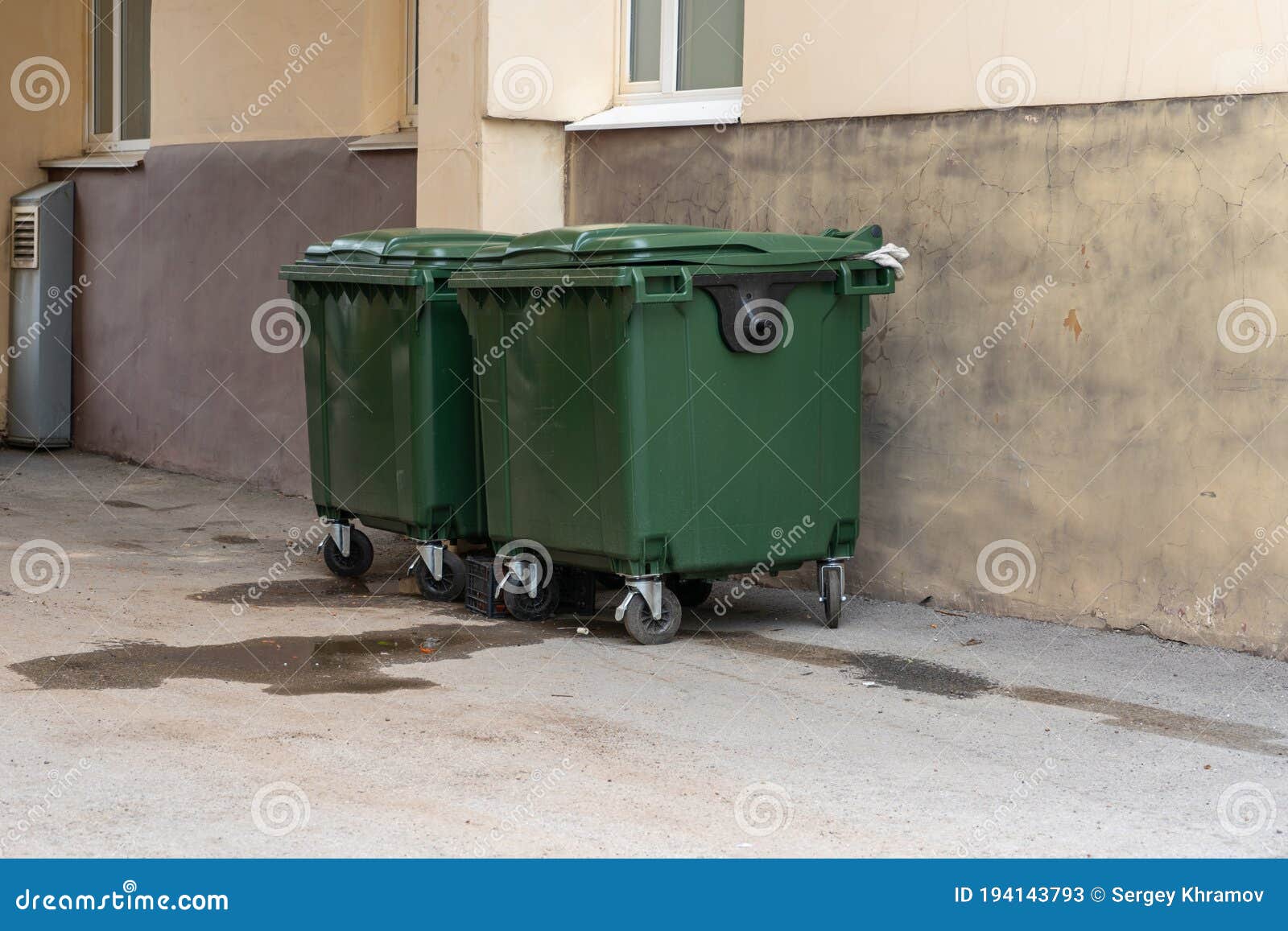 Green Plastic Garbage Containers Installed Along in the Yard of the ...