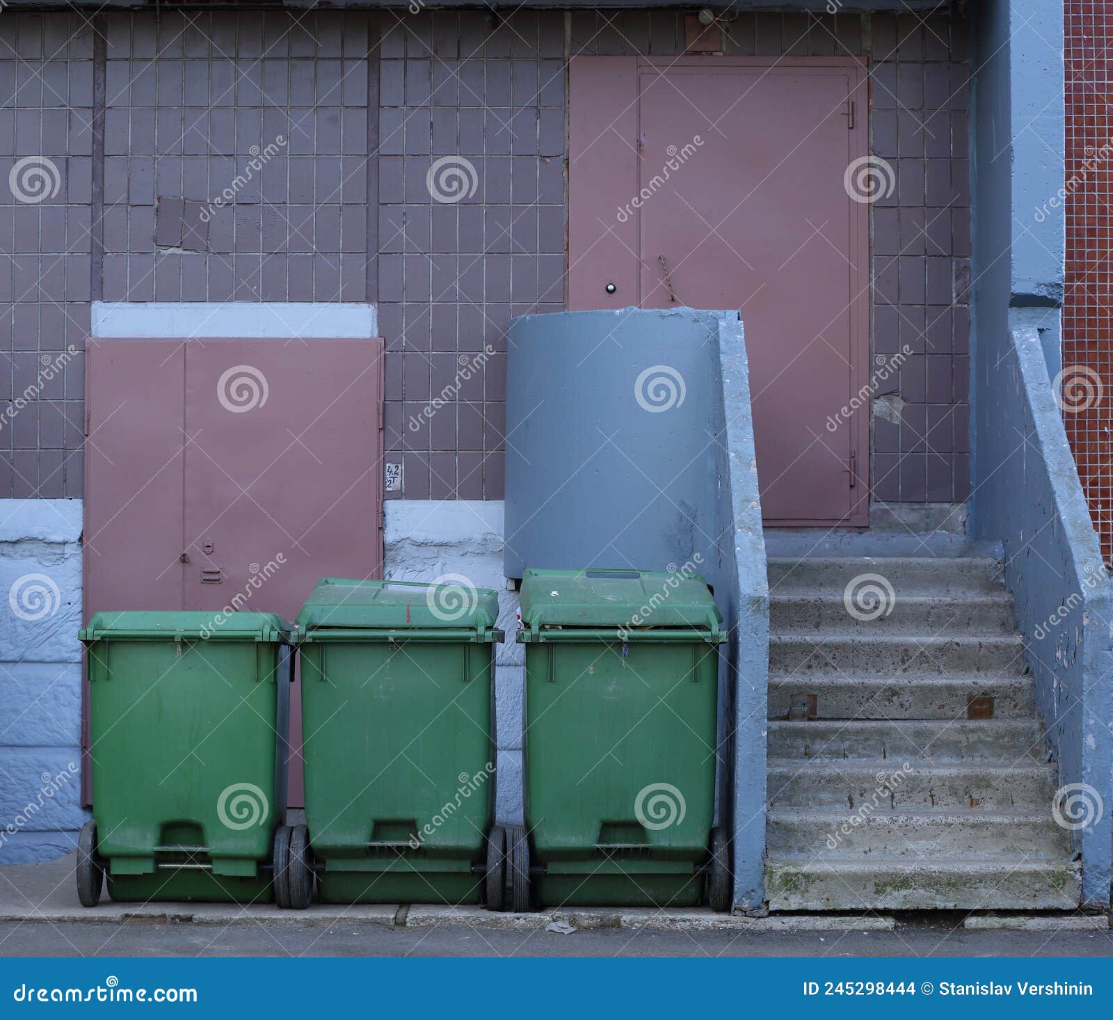 Green Plastic Mobile Containers with Garbage in the Courtyard of a ...