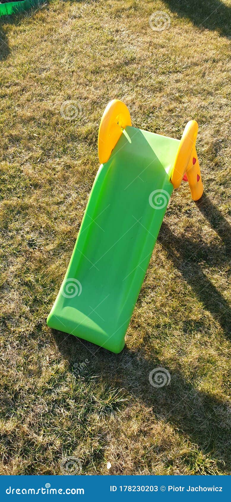 Green Plastic Slide on the Grass Stock Image - Image of furniture ...