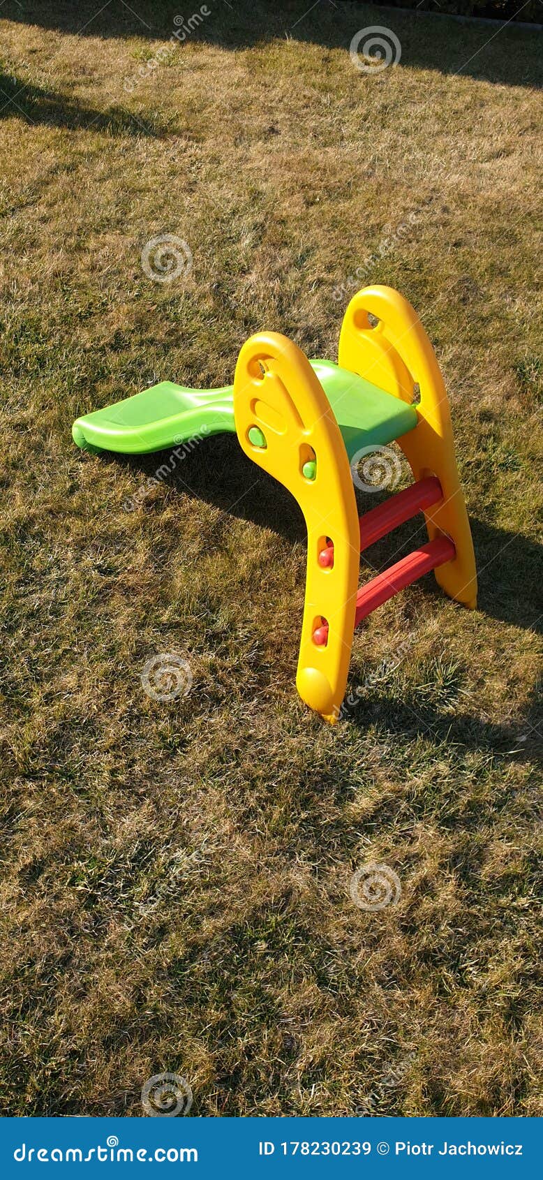 Green Plastic Slide on the Grass Stock Image - Image of grass, footwear ...