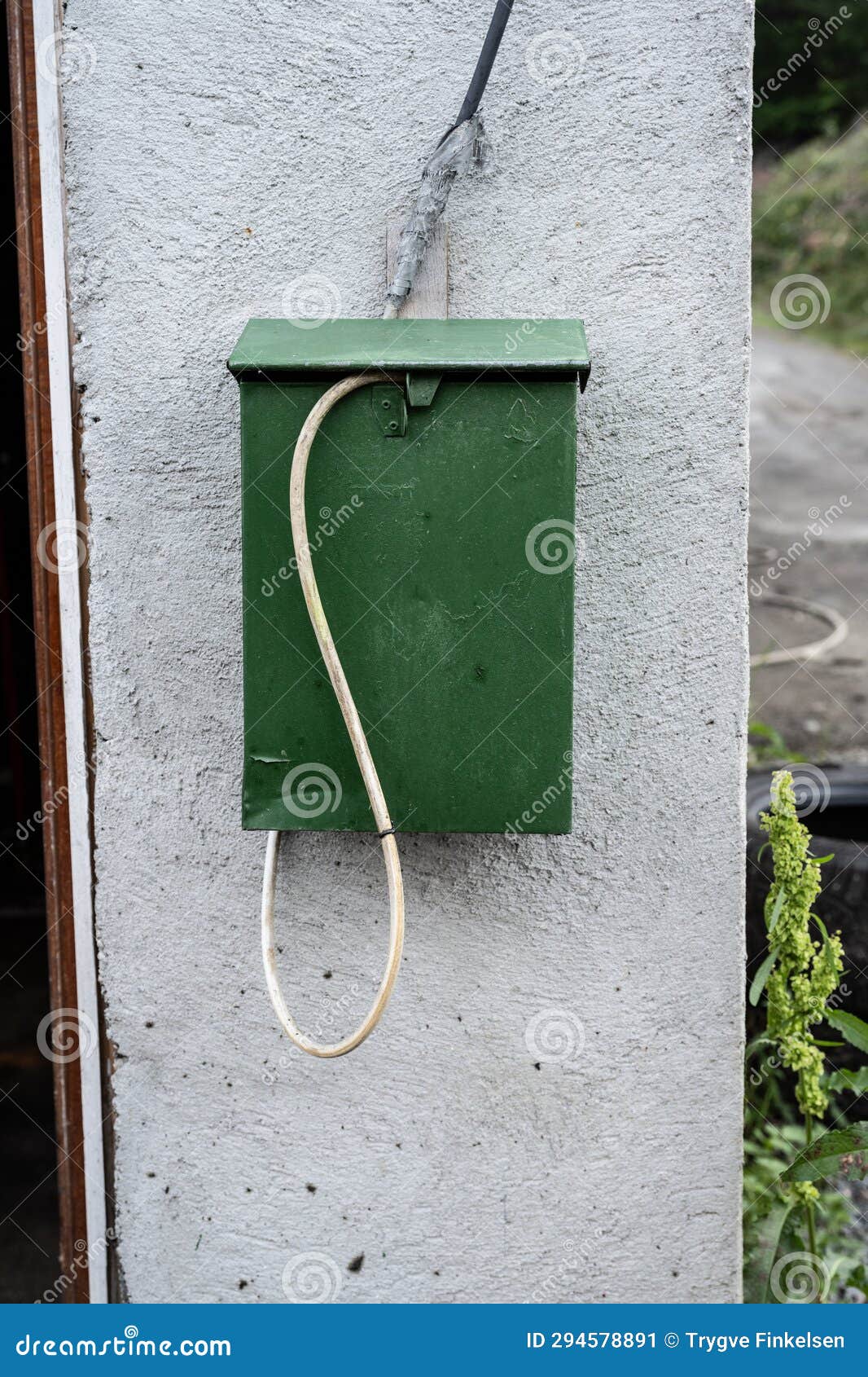 Green Post Box with a Mysterious Hos Sticking Out of it.. Stock Image ...