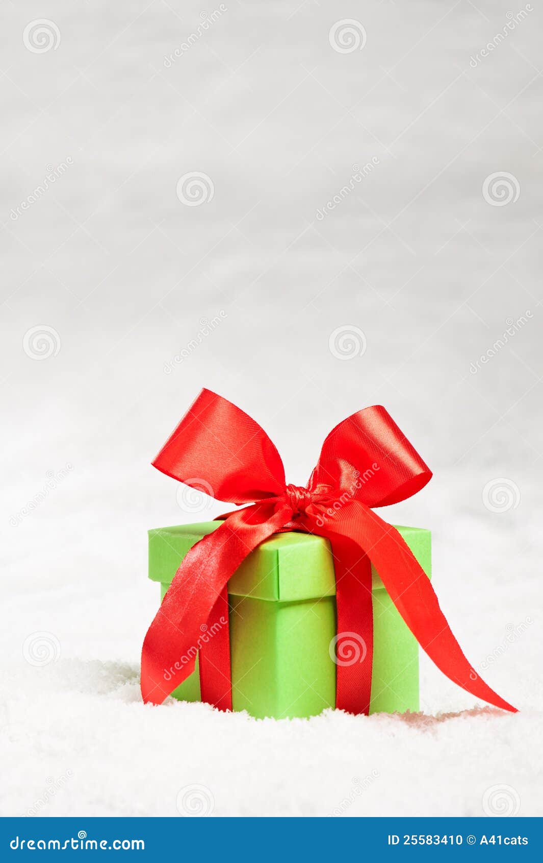 Green Present with Red Ribbon Over Snow Stock Photo - Image of modern ...