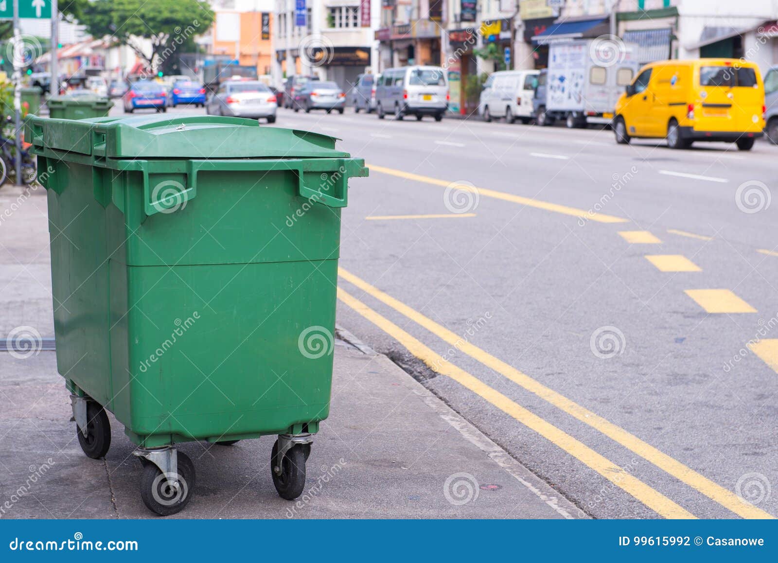 Green Recycling Bin Container or Garbage Trashcan on the Street Stock ...