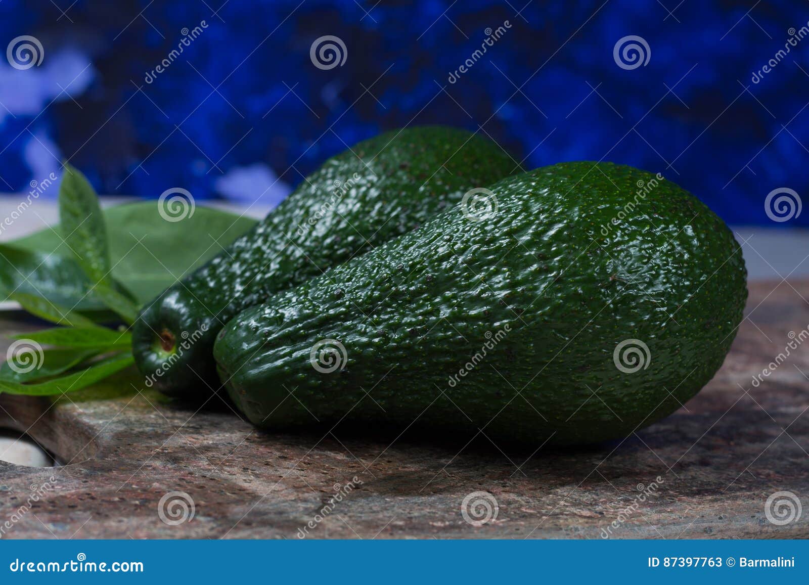 Green Ripe Avocado with Leaves on Granite Plank Stock Image - Image of ...