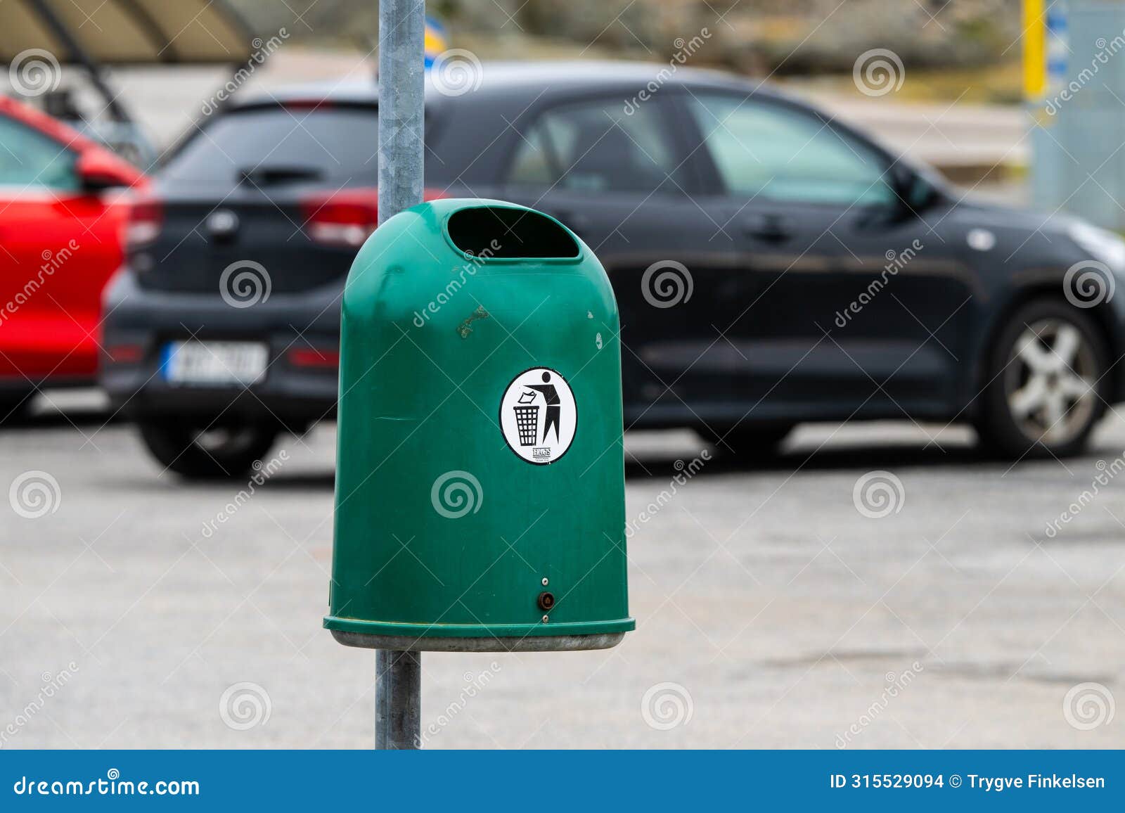 Green Round Plastic Trash Can by a Parking Lot.. Stock Photo - Image of ...