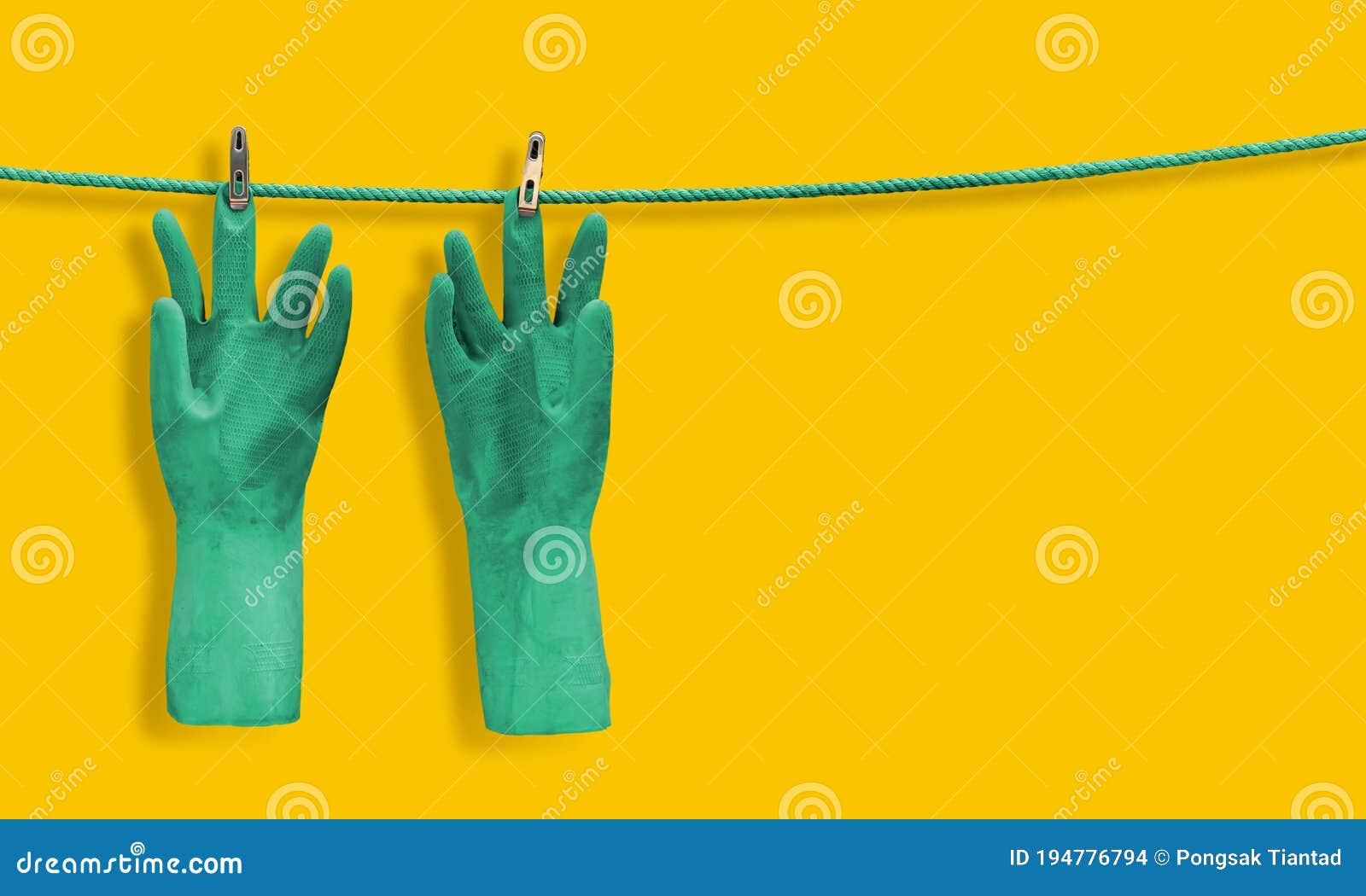 The Green Rubber Gloves are Hanging with the Plastic String on Yellow ...