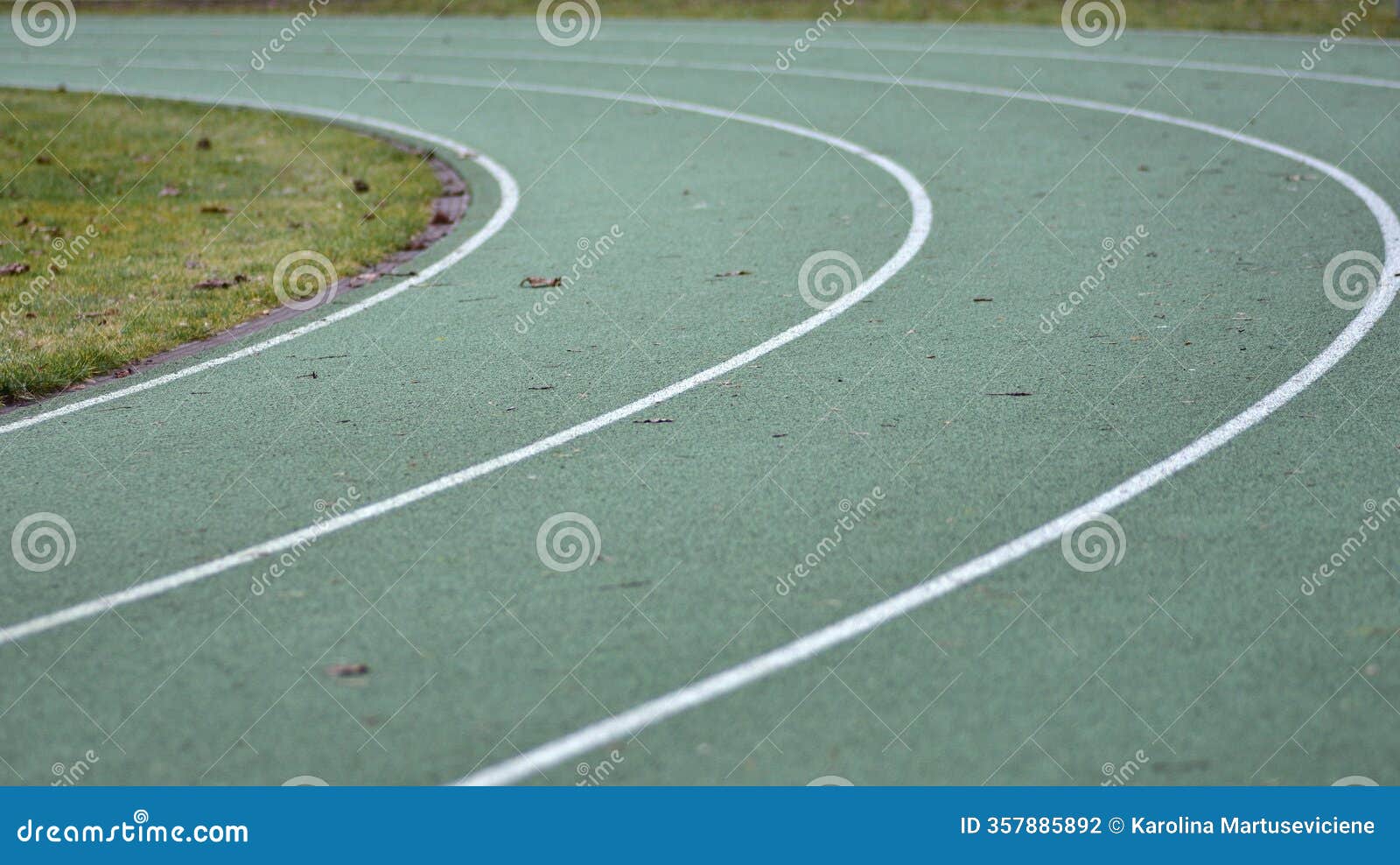 Green Running Track with White Lines and Green Grass in the Sides Stock ...