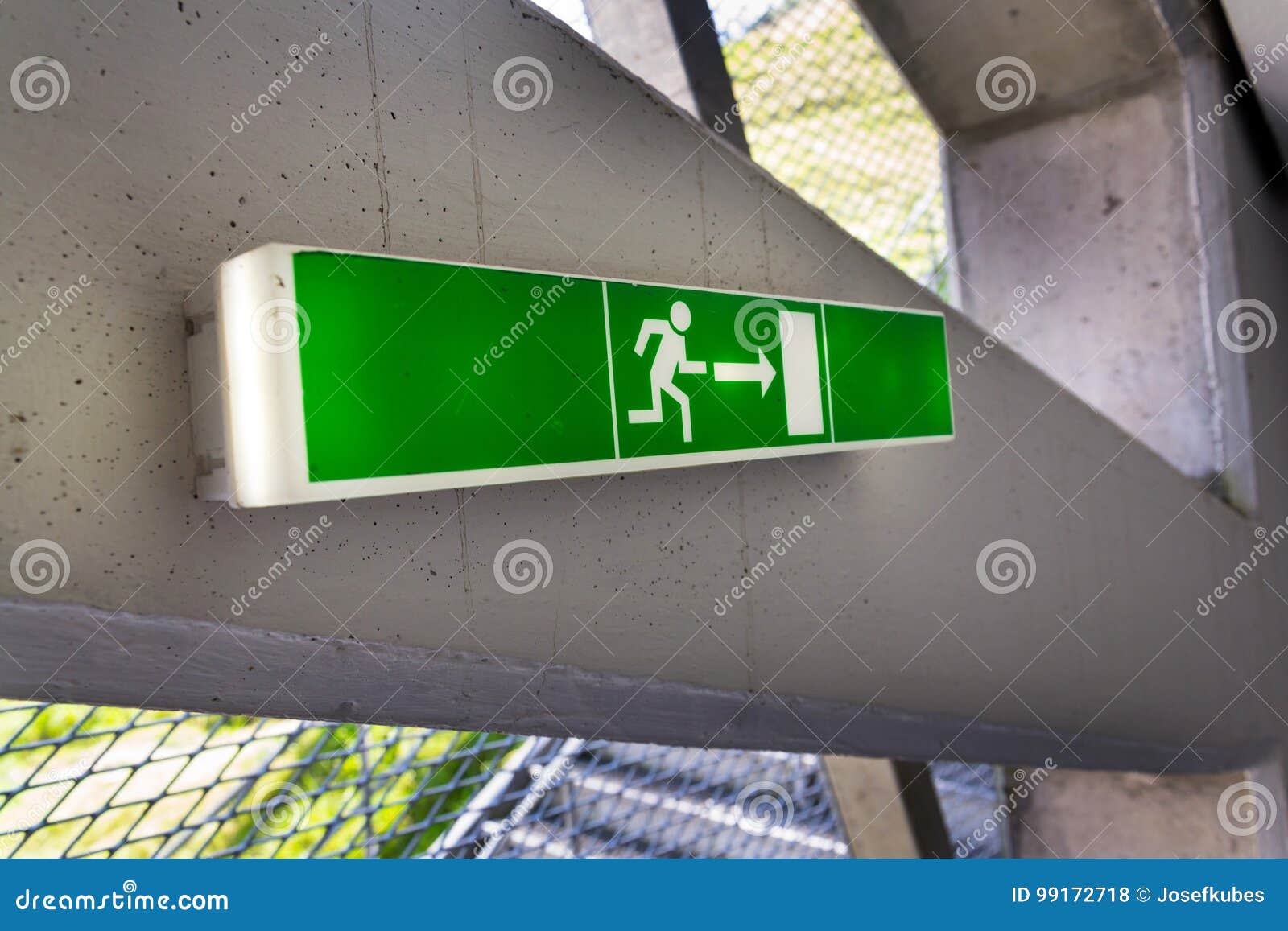 Green Escape Exit Sign on White Concrete Wall Stock Photo - Image of ...