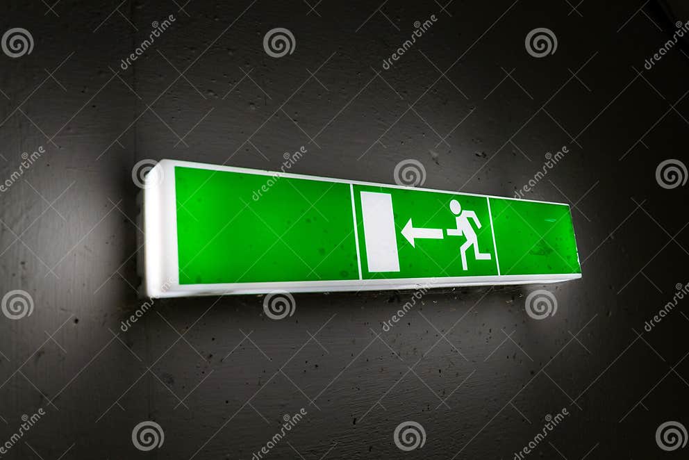 Green Escape Exit Sign on White Concrete Wall Stock Image - Image of ...