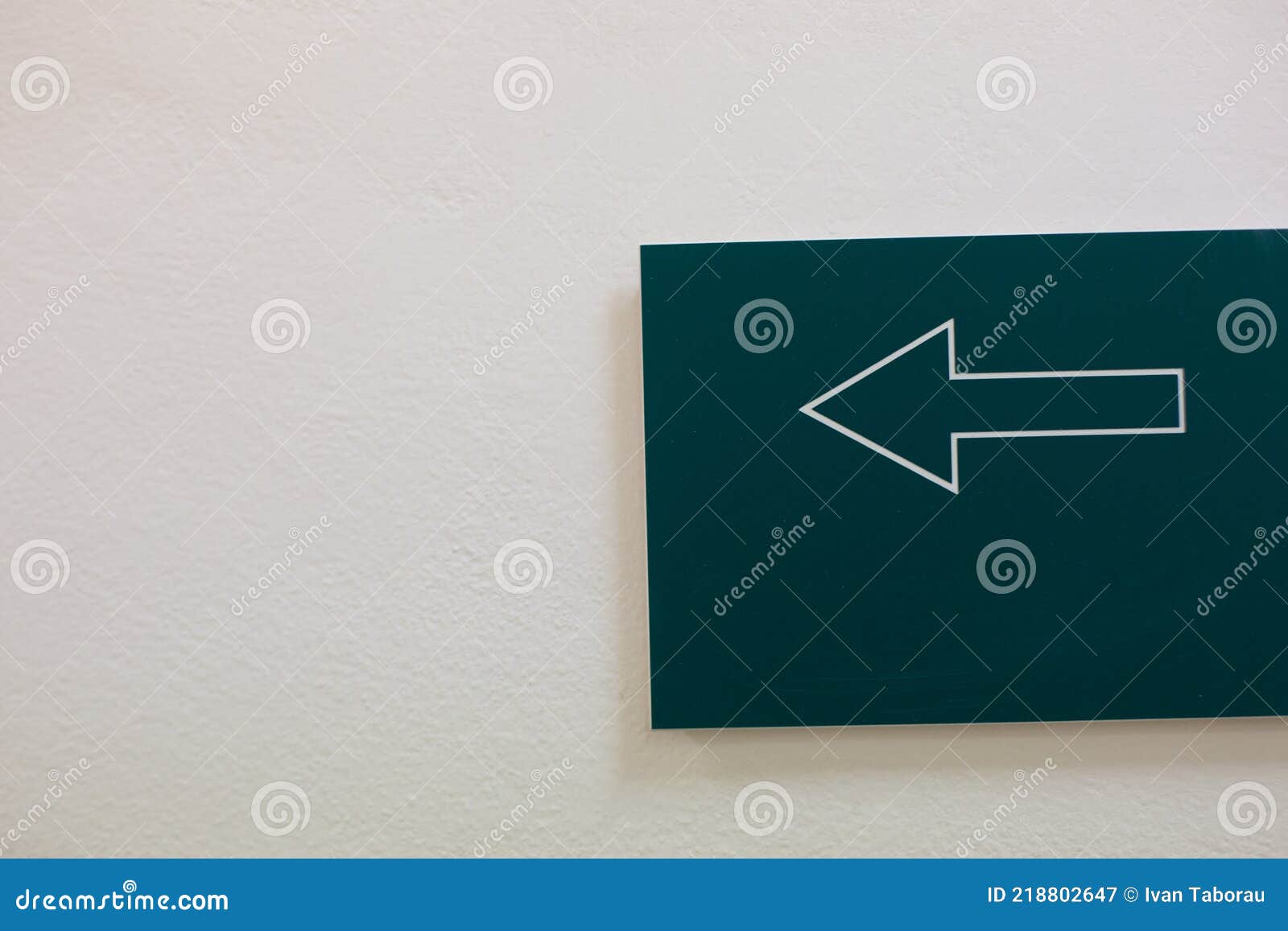 Green Sign with Direction Arrow To Left on White Wall Copy Space Stock ...