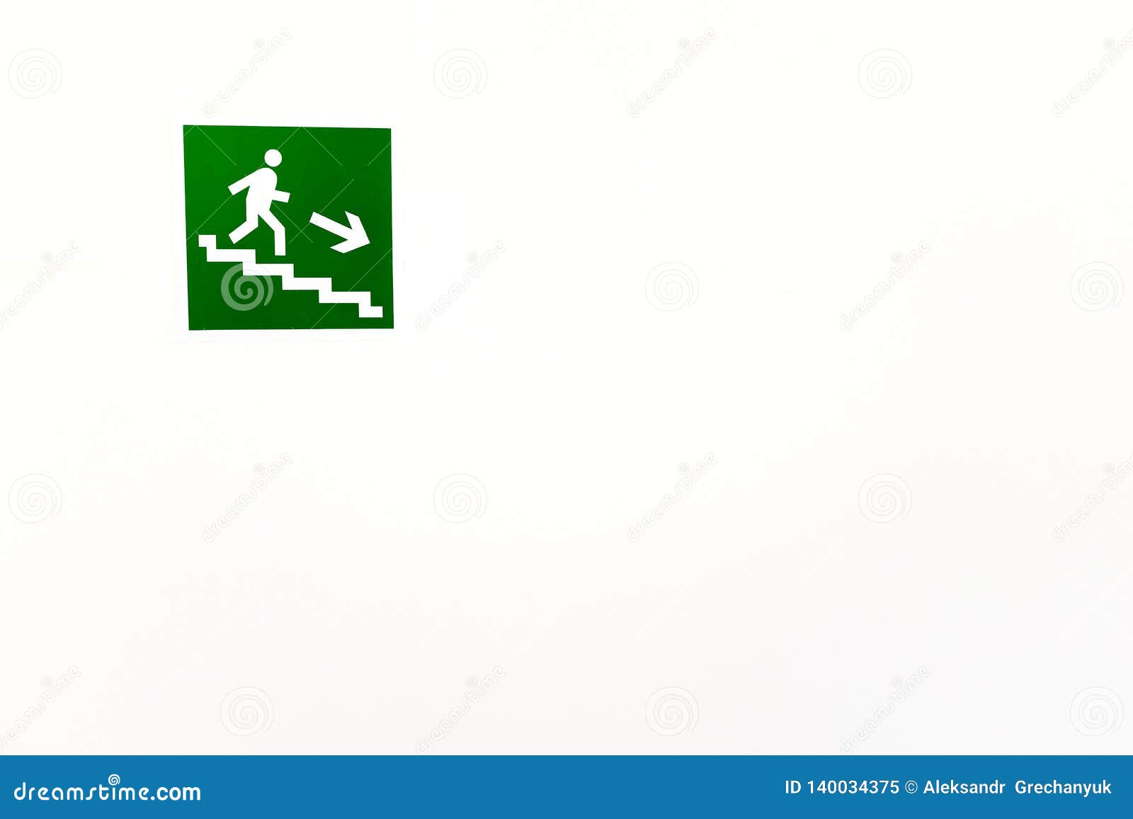 Green Sign Down the Stairs on an Empty Bright Wall Stock Image - Image ...