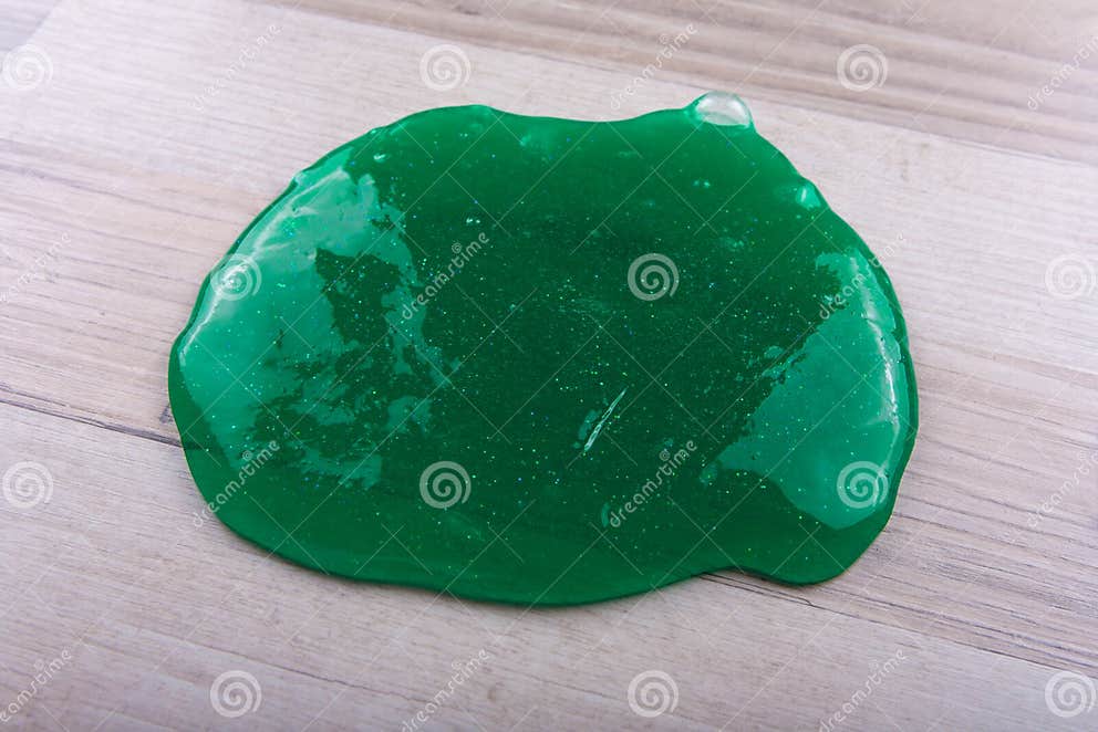 Green slime on a table stock image. Image of abstract - 137538371