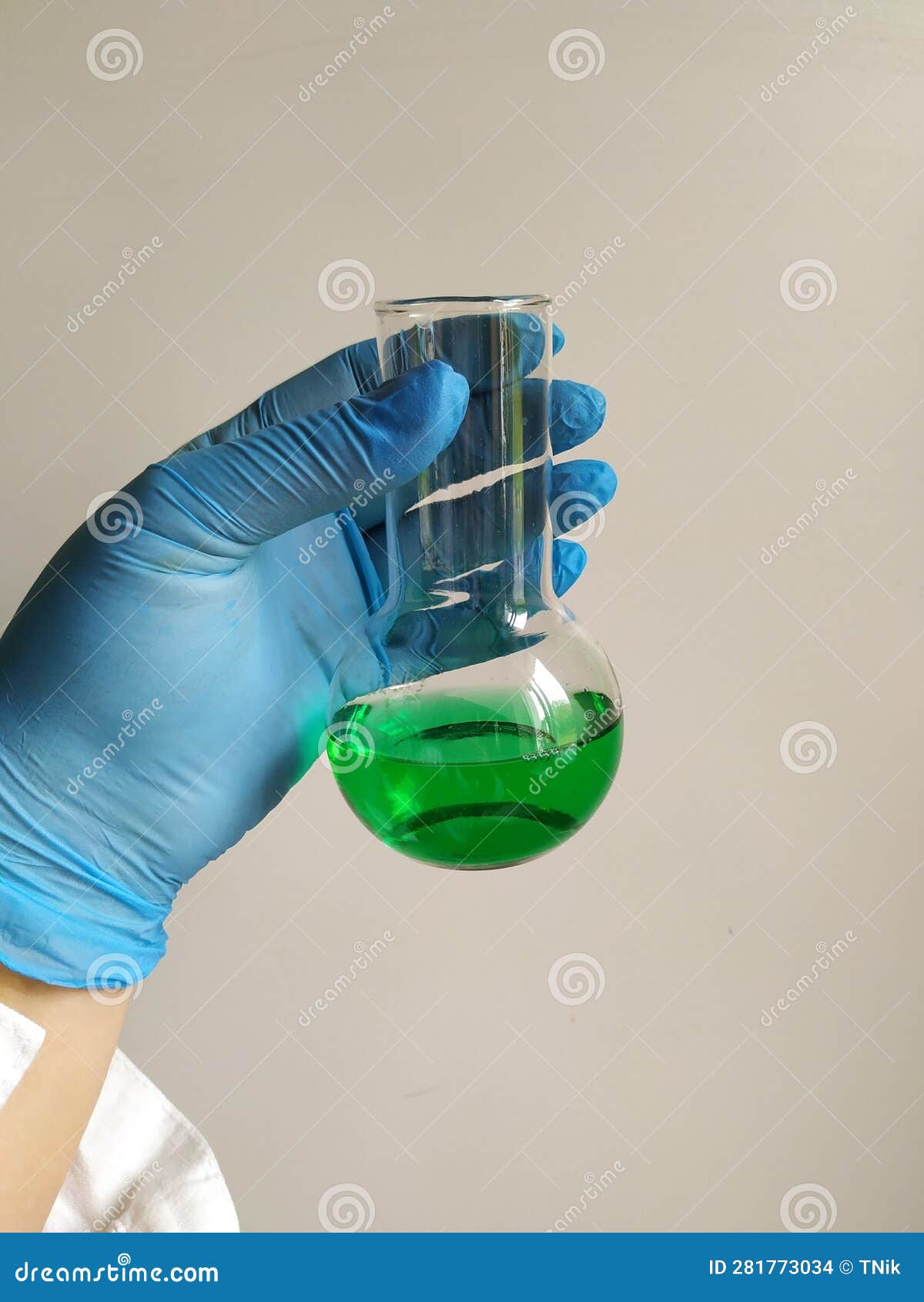 Green Solution in a Glass Flask in the Scientist S Hand. Stock Photo ...