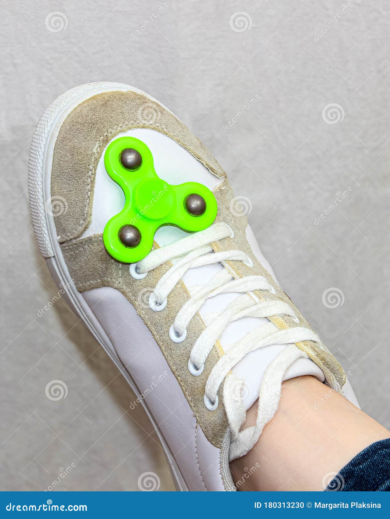 Green Spinner Spin on Your Foot on a Sneaker Stock Photo - Image of ...