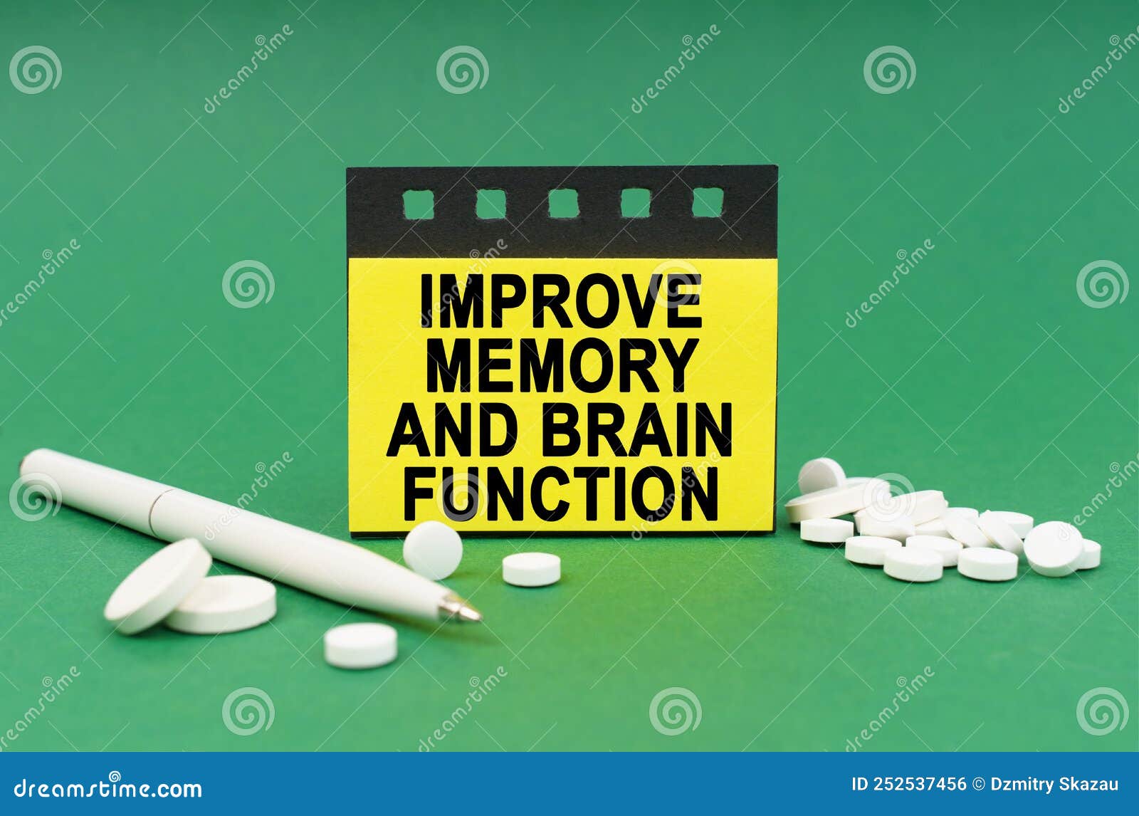 On the Green Surface are Tablets, a Pen and Stickers with the ...