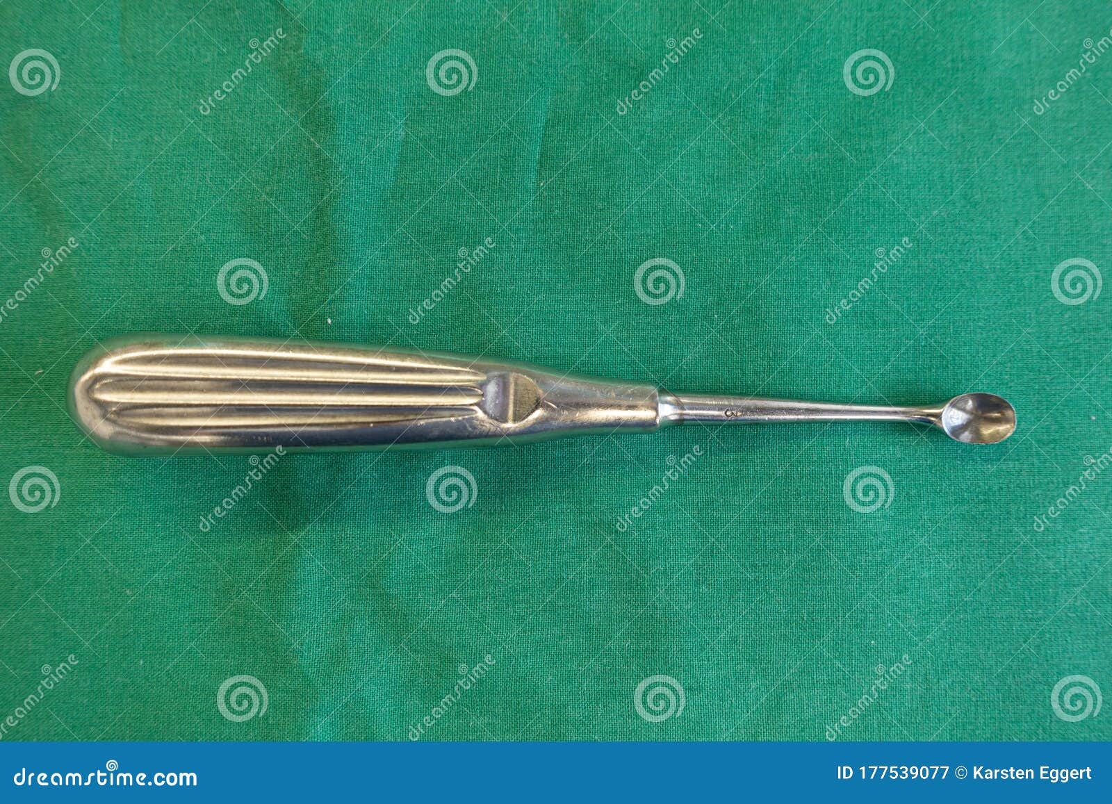 On Green Surgical Drape Lies a Sharp Spoon for an Operation Stock Image ...