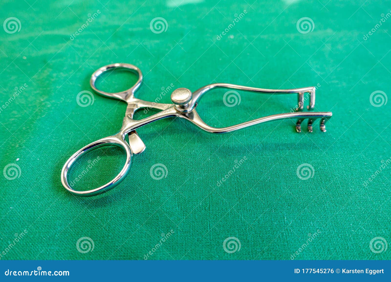 On Green Surgical Sheet Lies a Surgical Retractor Stock Photo - Image ...
