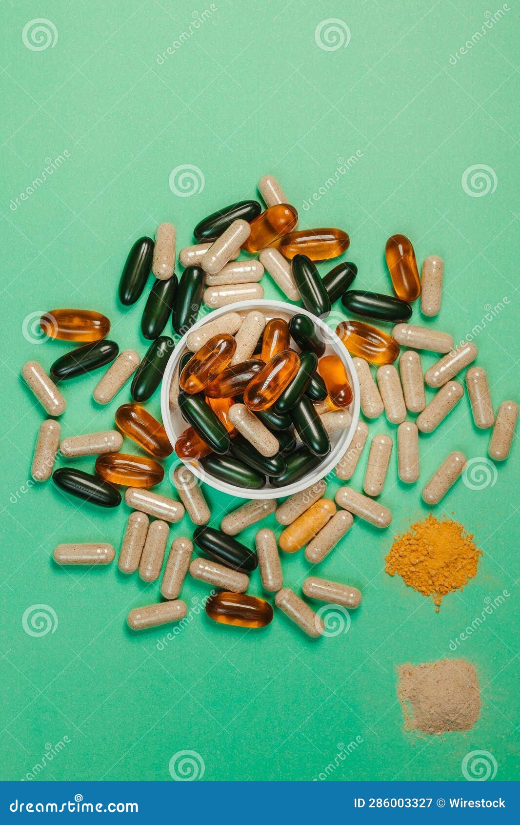 Green Tabletop with an Array of Vitamin Supplement Capsules and Pills ...