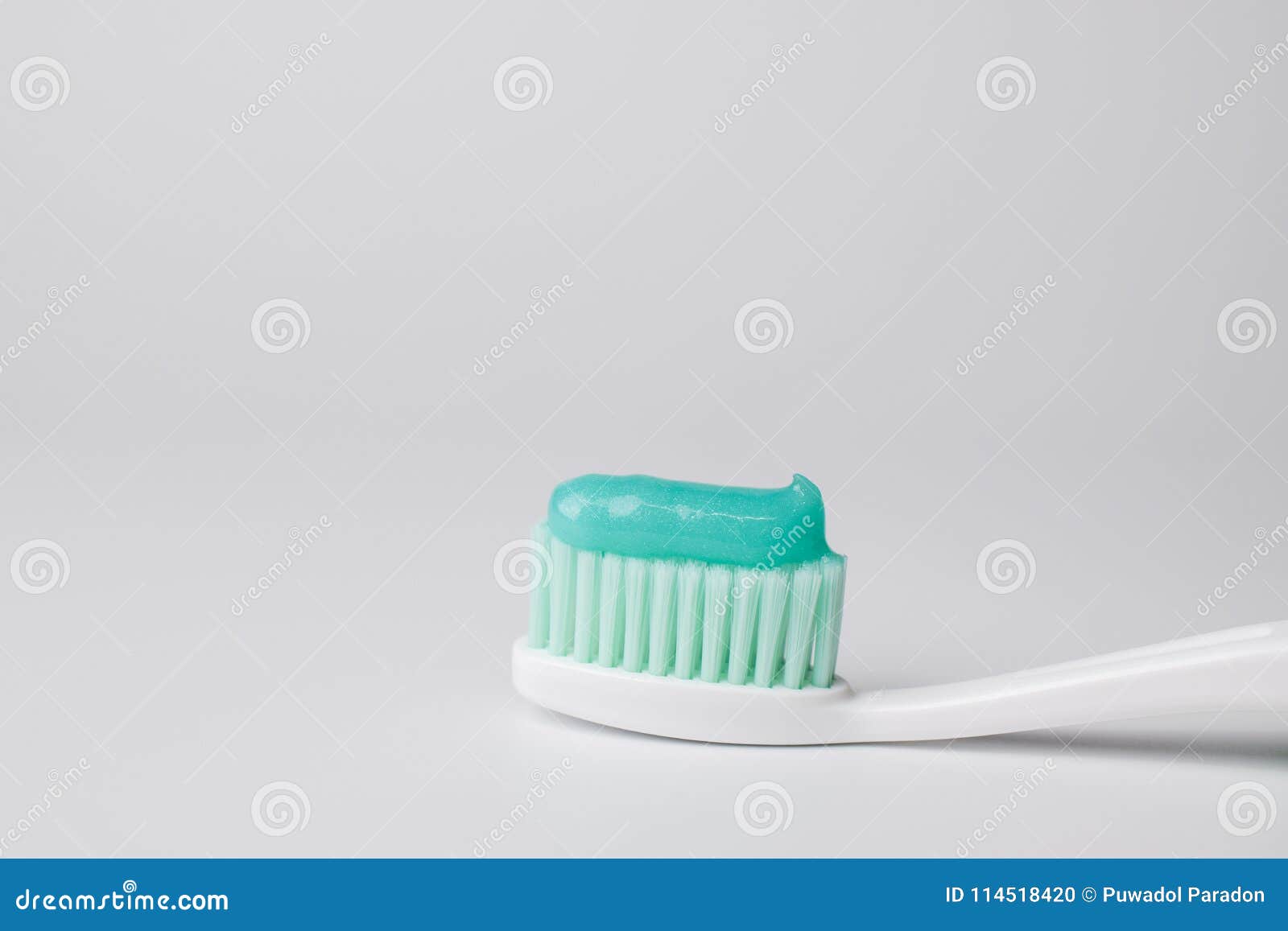 Green Toothpaste on a Toothbrush on White Background Stock Photo ...