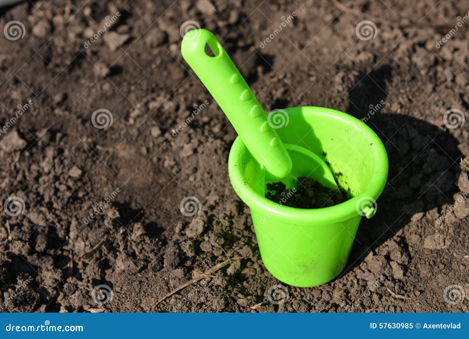 Green Toy Bucket and Spade in Mud Stock Image - Image of shovel ...