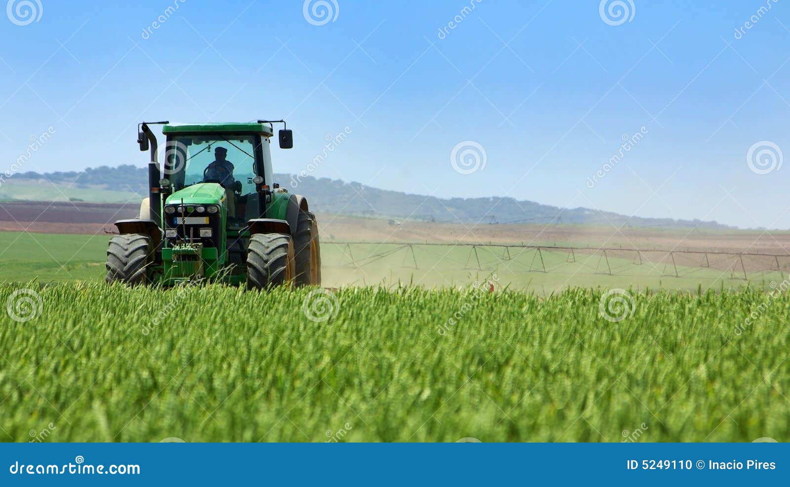 Green Tractor in the Field. Editorial Image - Image of blue, rural: 5249110