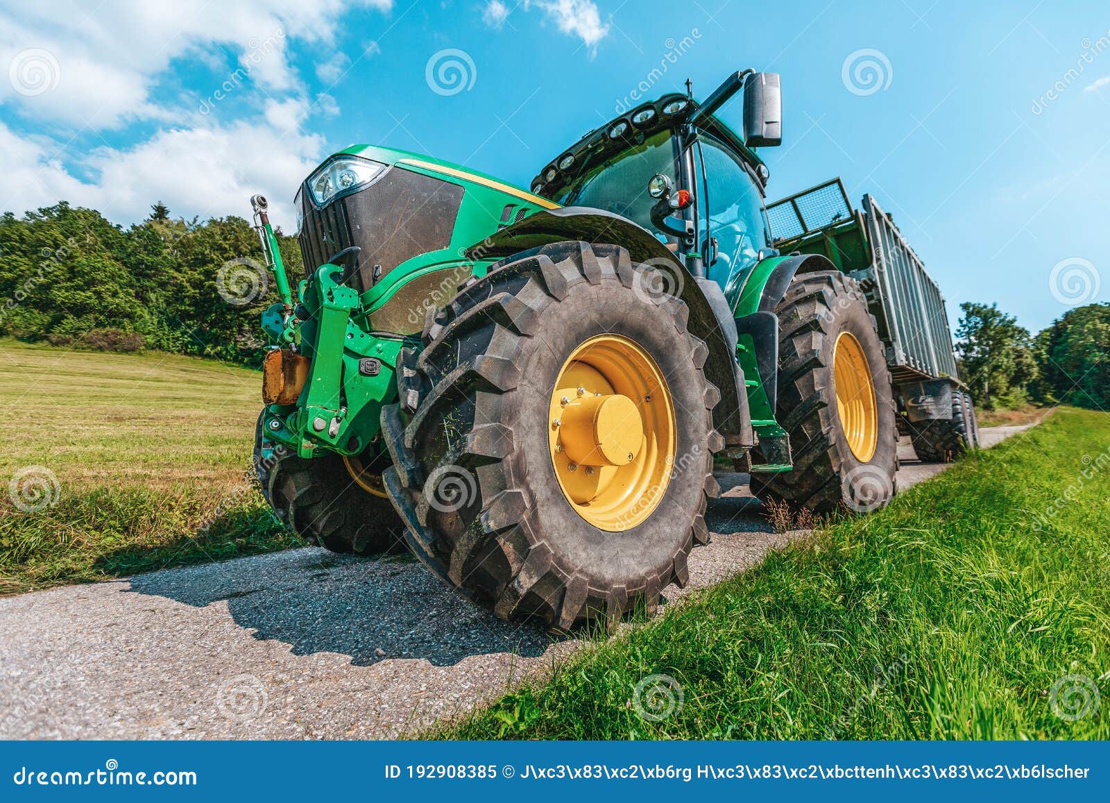Green Tractor with a Loader Wagon on a Road Editorial Image - Image of ...