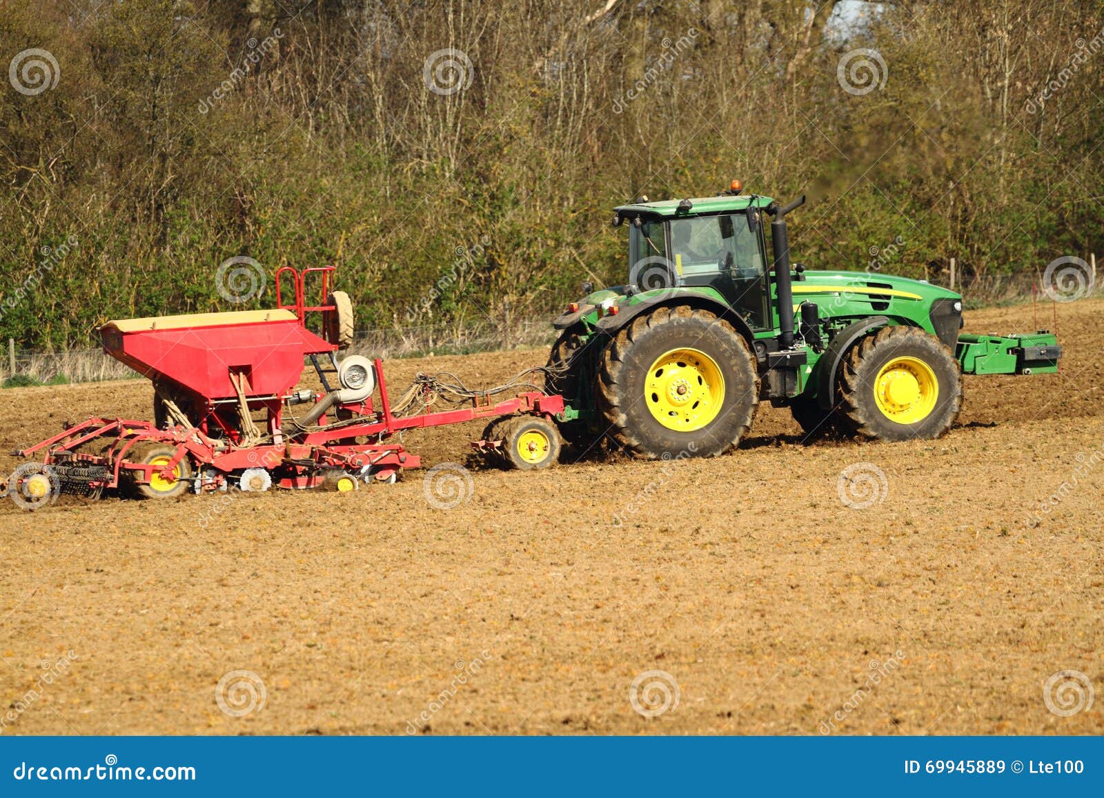 Green tractor sowing seeds editorial stock image. Image of crops - 69945889