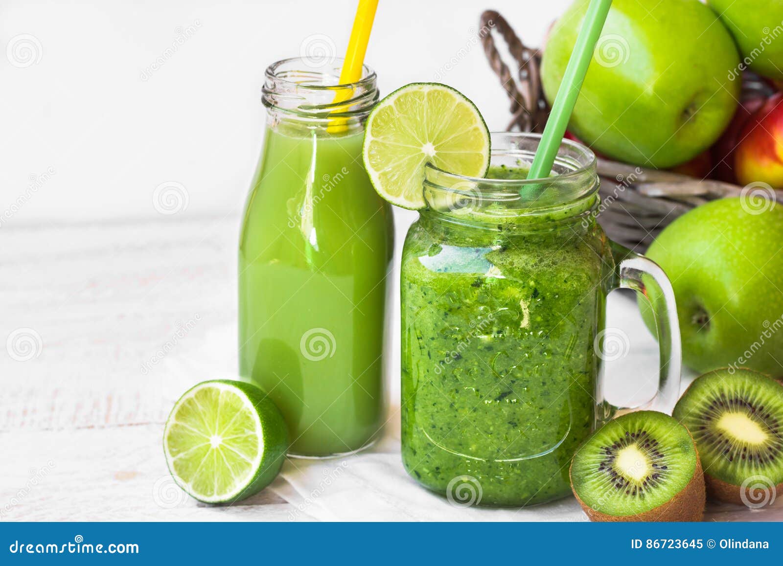 Green Vegetable Smoothie In Glass Mug And Fruit Juice In Bottle With