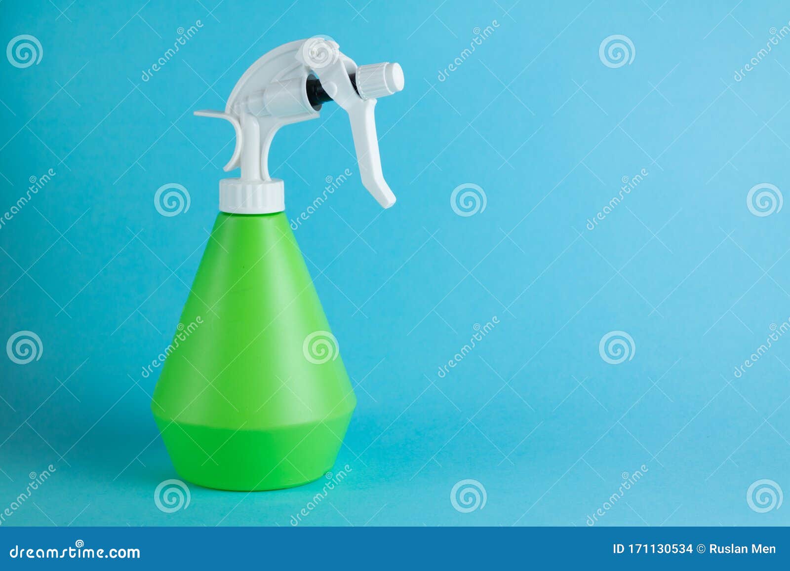 Green Water Spray Bottle on a Blue Background Stock Photo - Image of ...