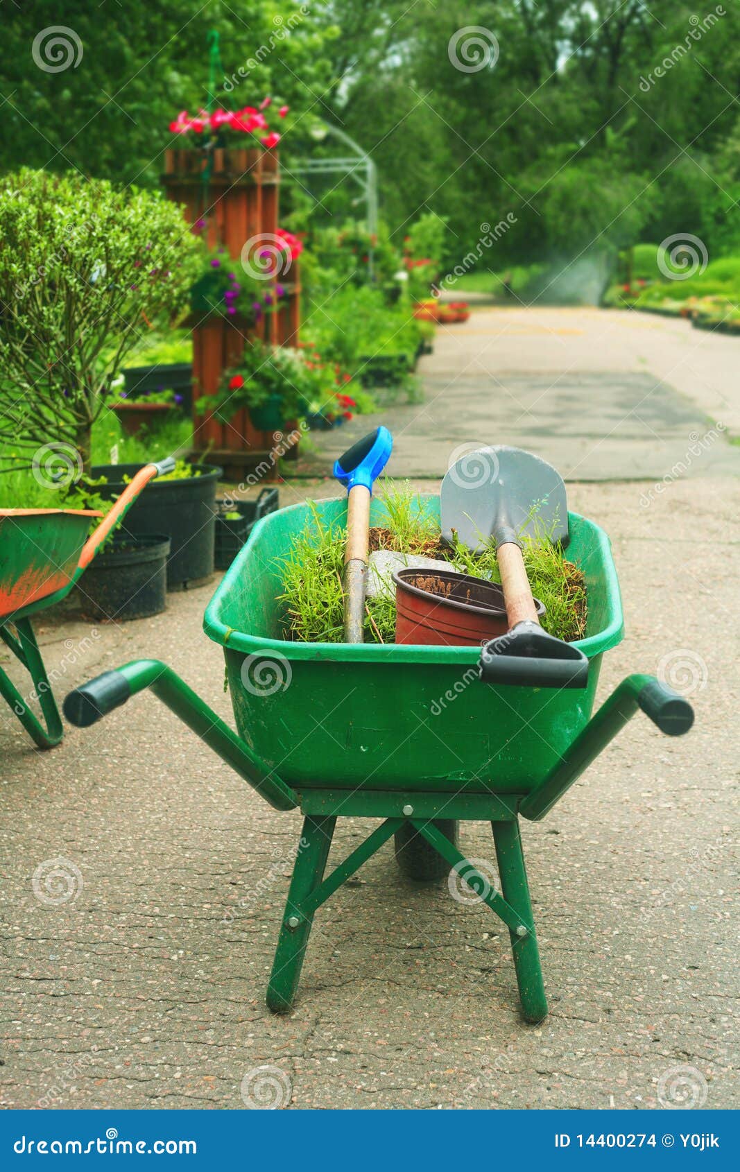 Green wheelbarrow stock photo. Image of outdoor, tree - 14400274