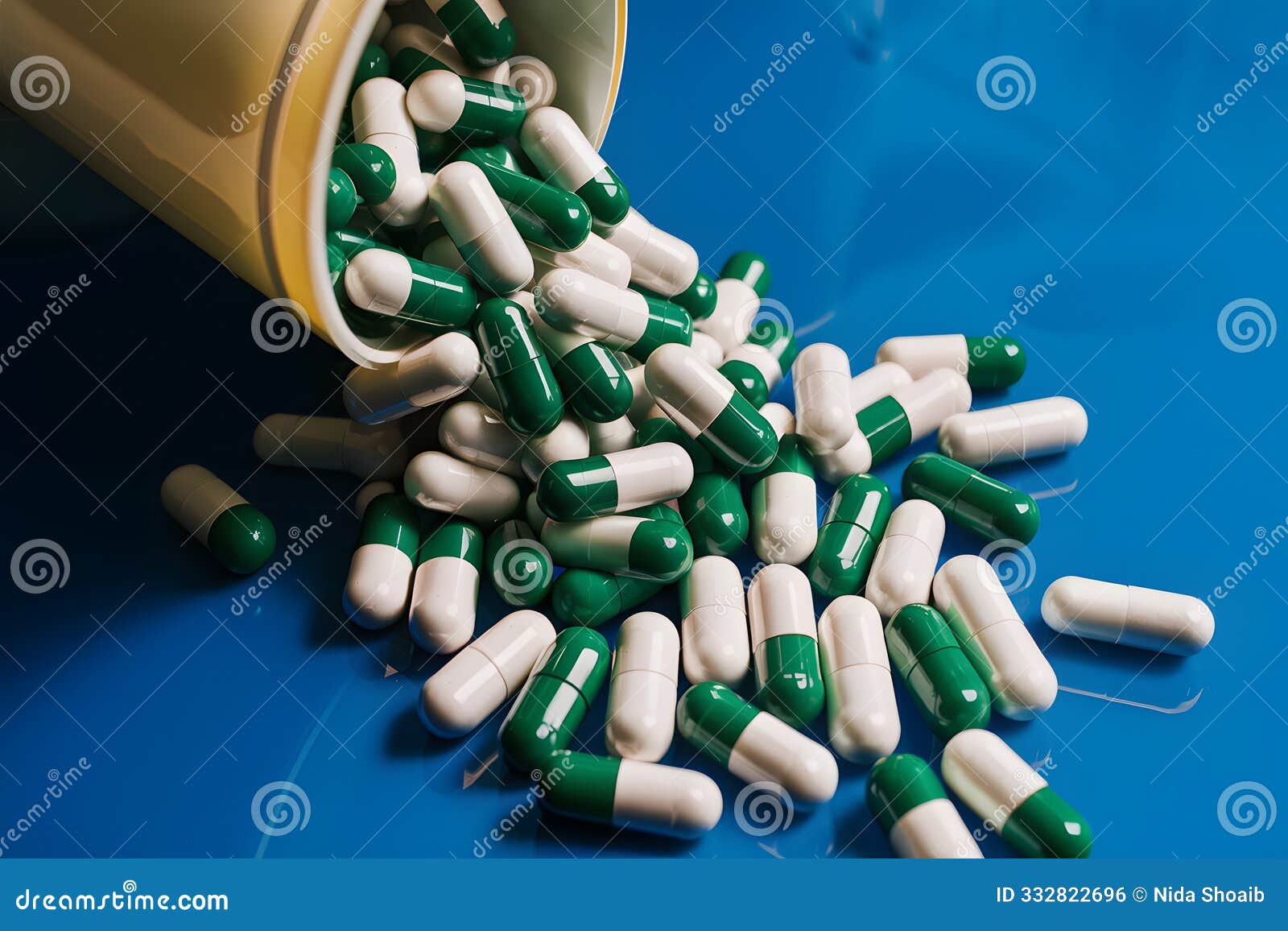Green And White Capsules Falling From Cylindrical Container Onto Blue ...