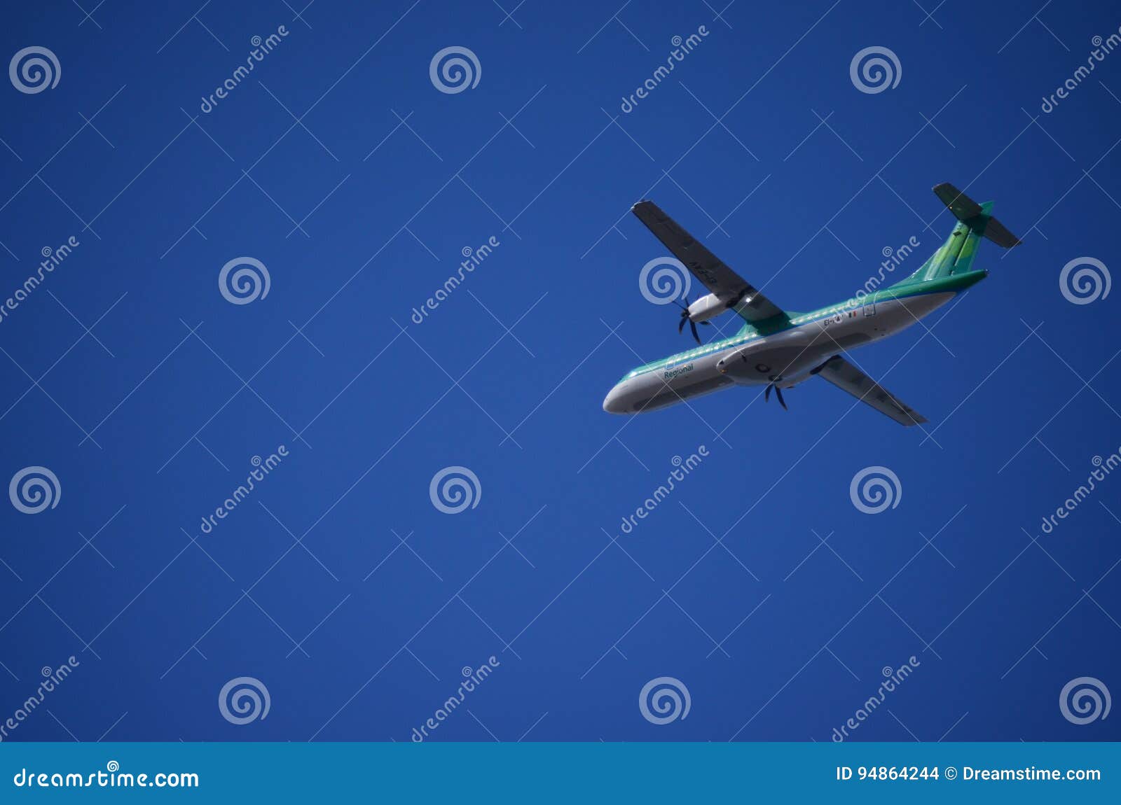 Green and White Double Helix Regional Airplane Flying Left Editorial ...