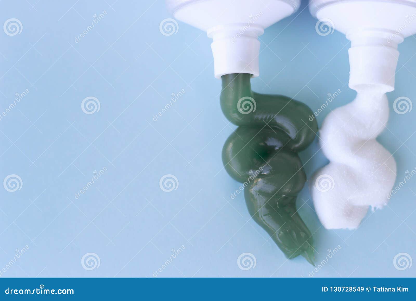 Green and White Toothpaste Squeezed Out of Tubes on Blue Background ...