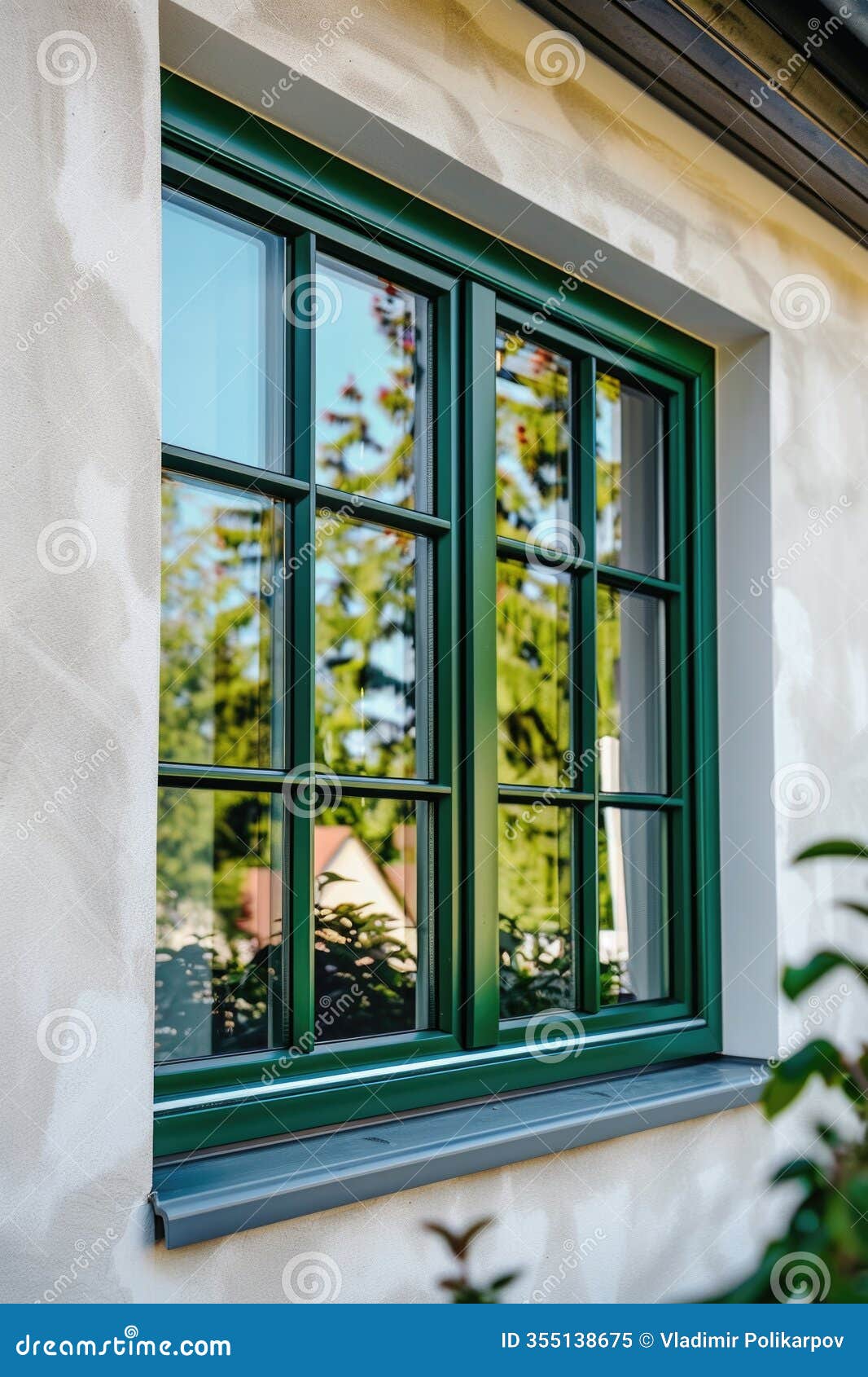A Green Window on a White Building with Trees in the Background ...