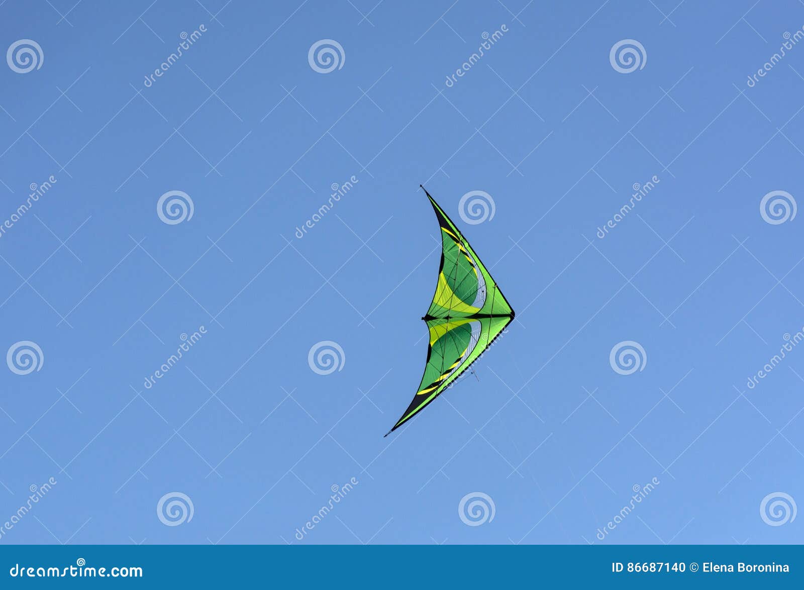 Green with Yellow Kite Floating in the Blue Sky Stock Photo - Image of ...