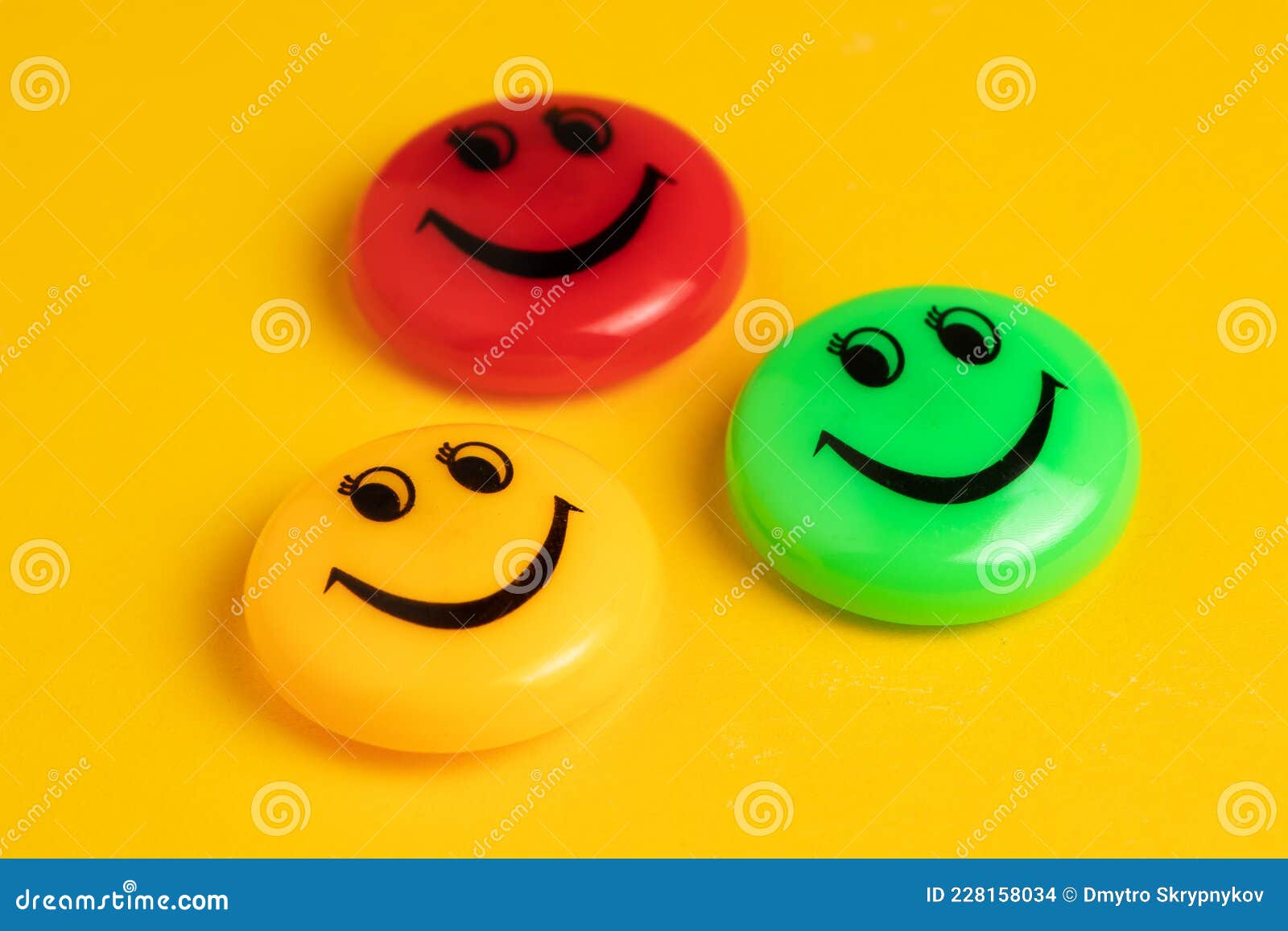 Green Yellow and Red Round Magnet with Smile in a Row on a Yellow ...