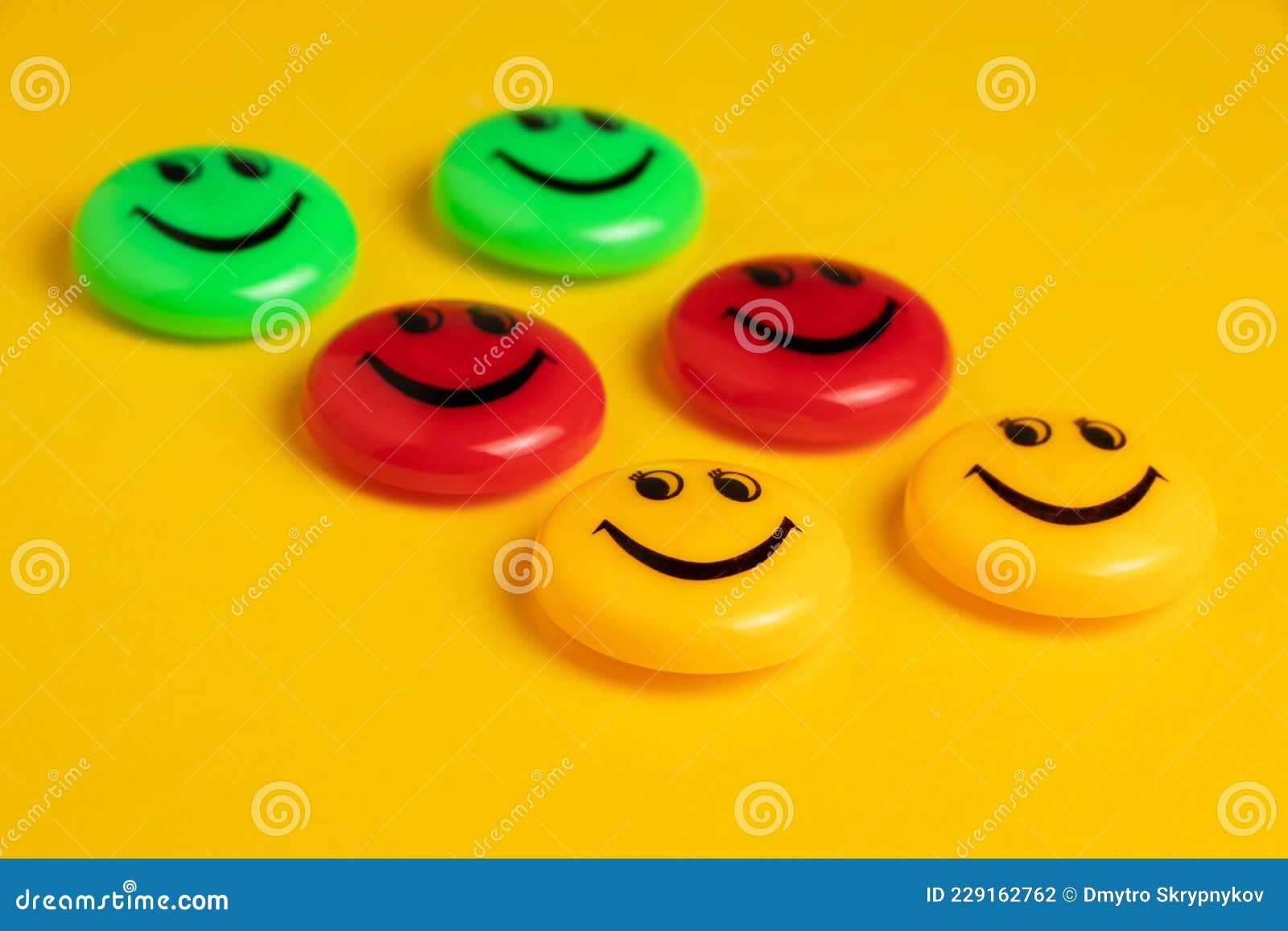 Green Yellow and Red Round Magnet with Smile in a Row on a Yellow ...