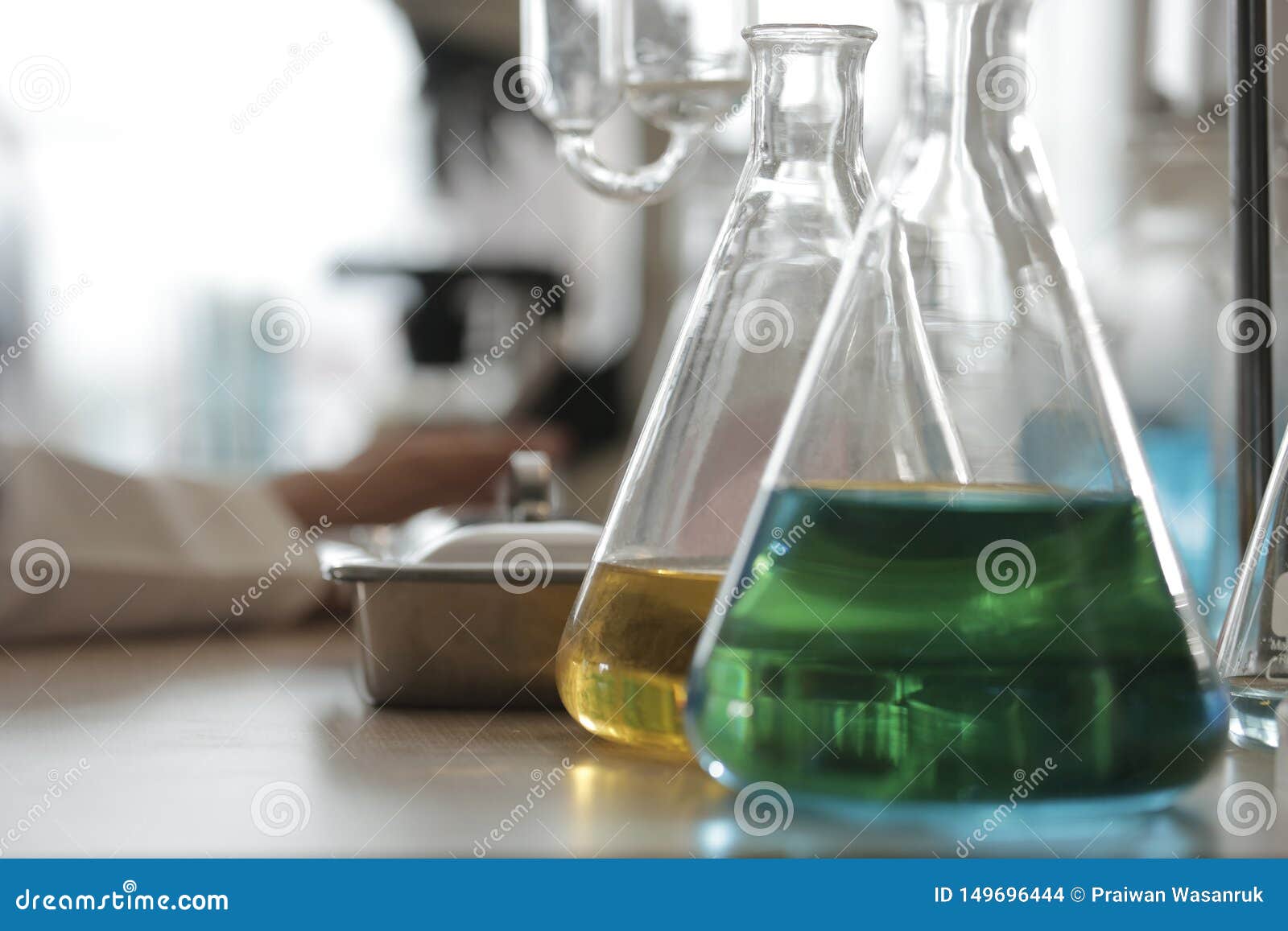Green and Yellow Solutions in Beaker Stock Photo - Image of ...