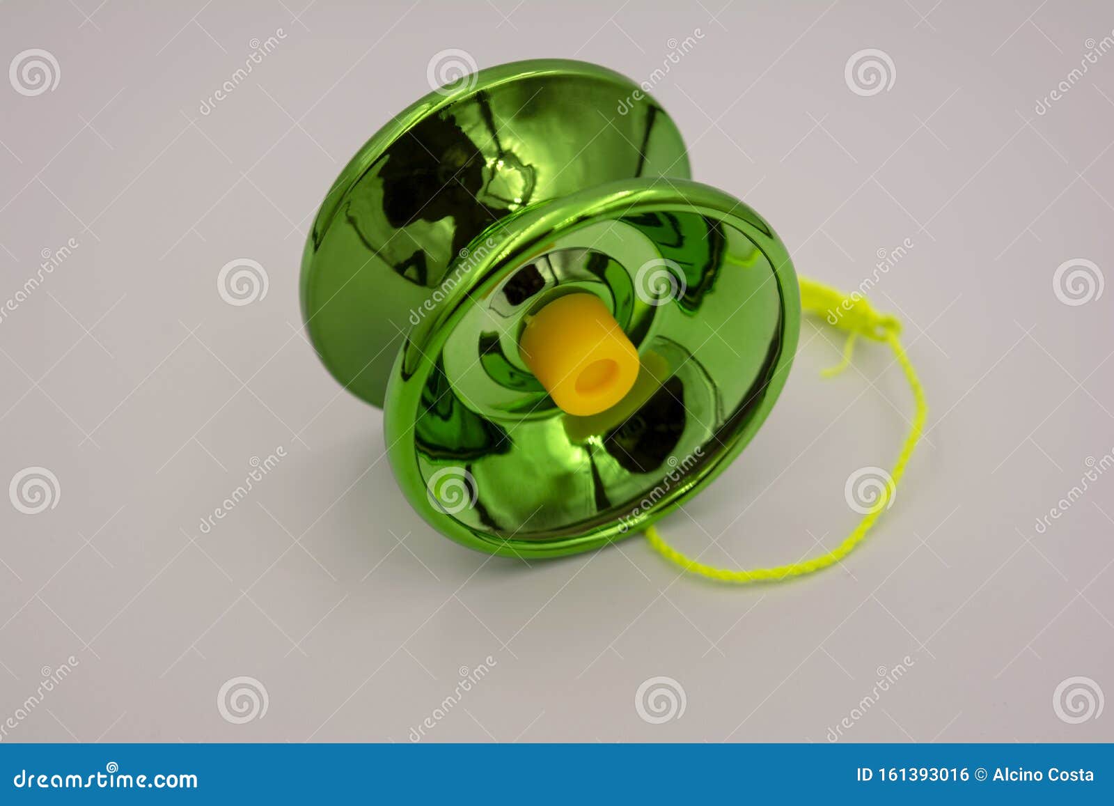 Green Yo-Yo Toy with Yellow String Stock Photo - Image of outside ...