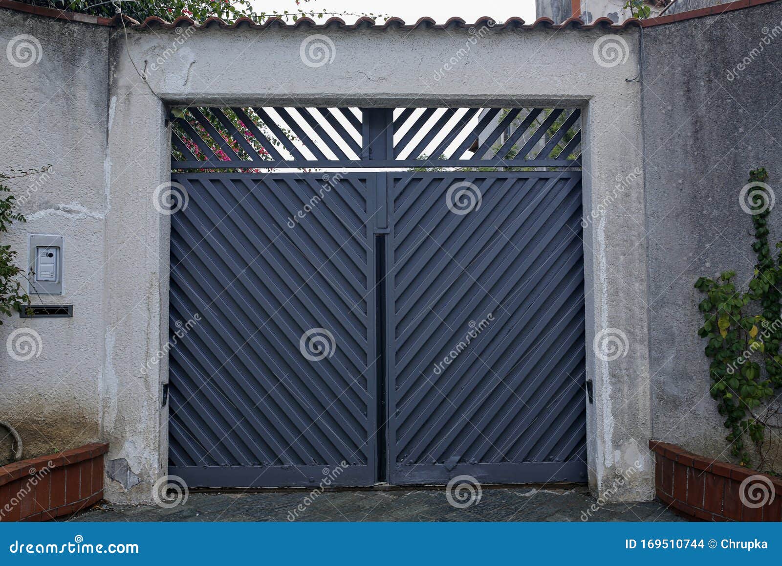 Grey gate in stone wall stock photo. Image of shelter - 169510744