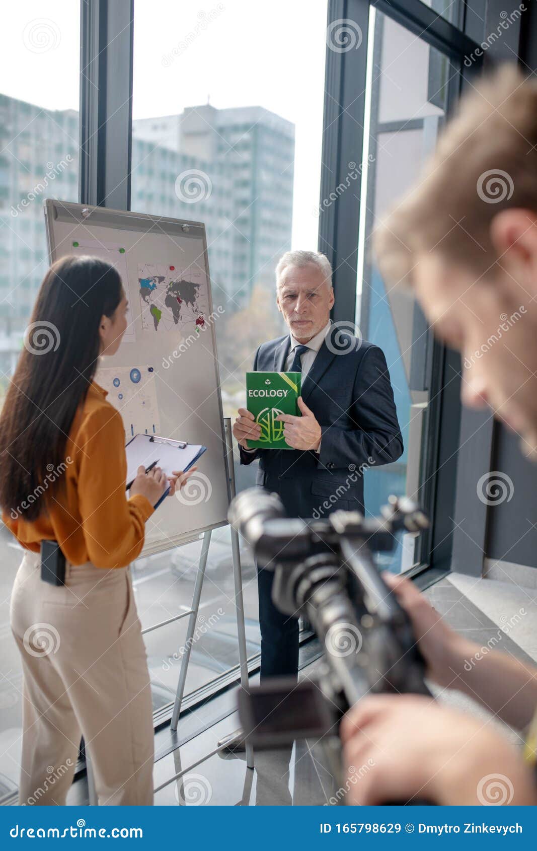 Grey-haired Man Talking To a Young Reporter in the Studio Stock Image ...