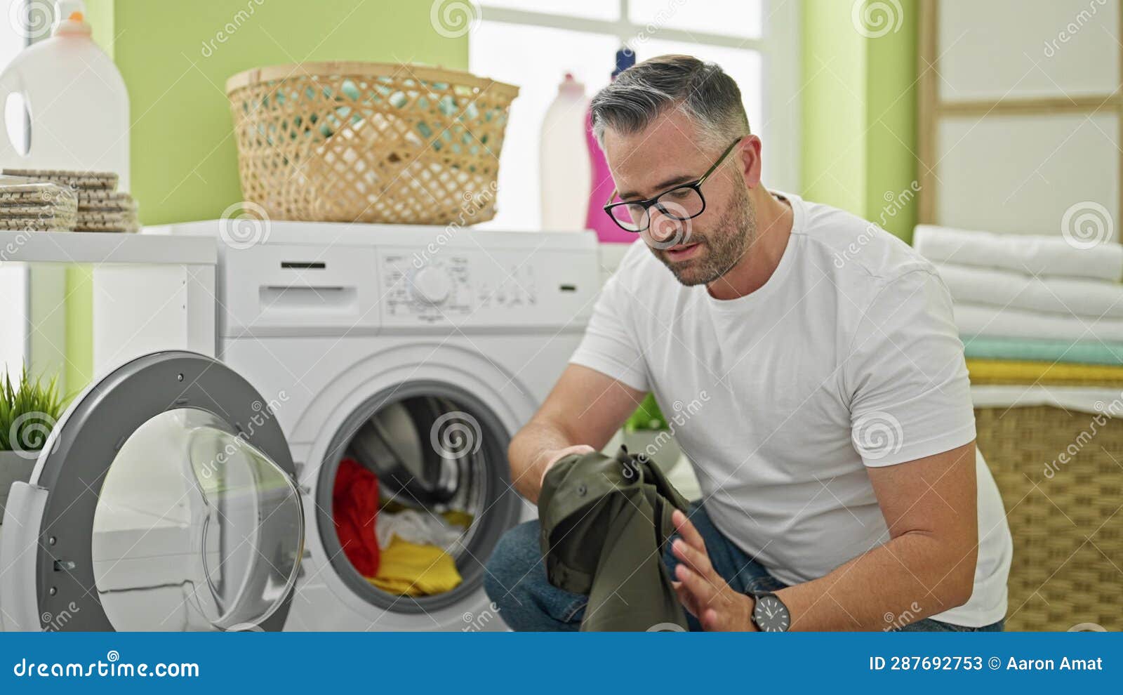Grey-haired Man Washing Clothes at Laundry Room Stock Video - Video of housework, person: 287692753