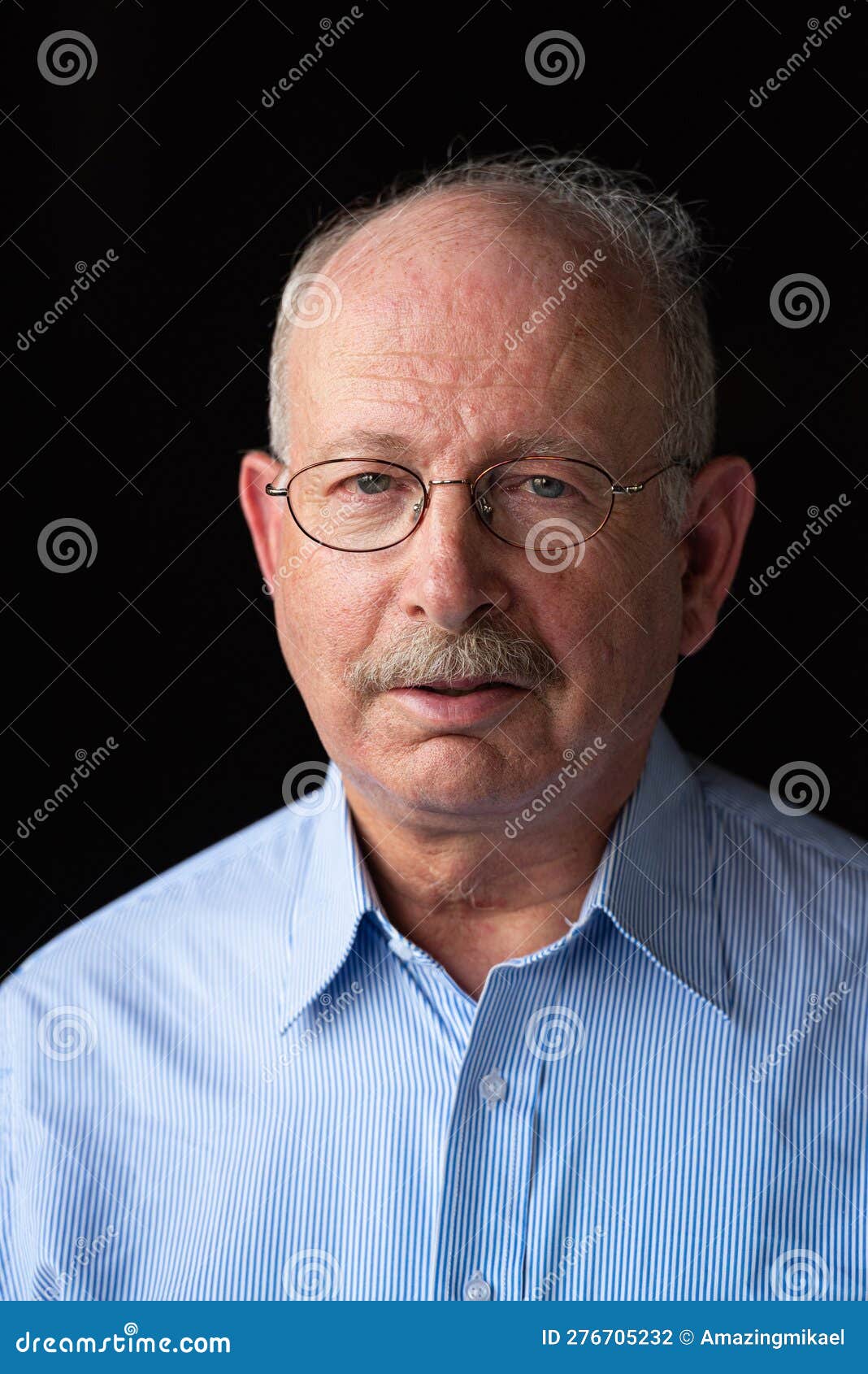 Grey Haired Senior Man With Mustache Wearing Eyeglasses Against Black