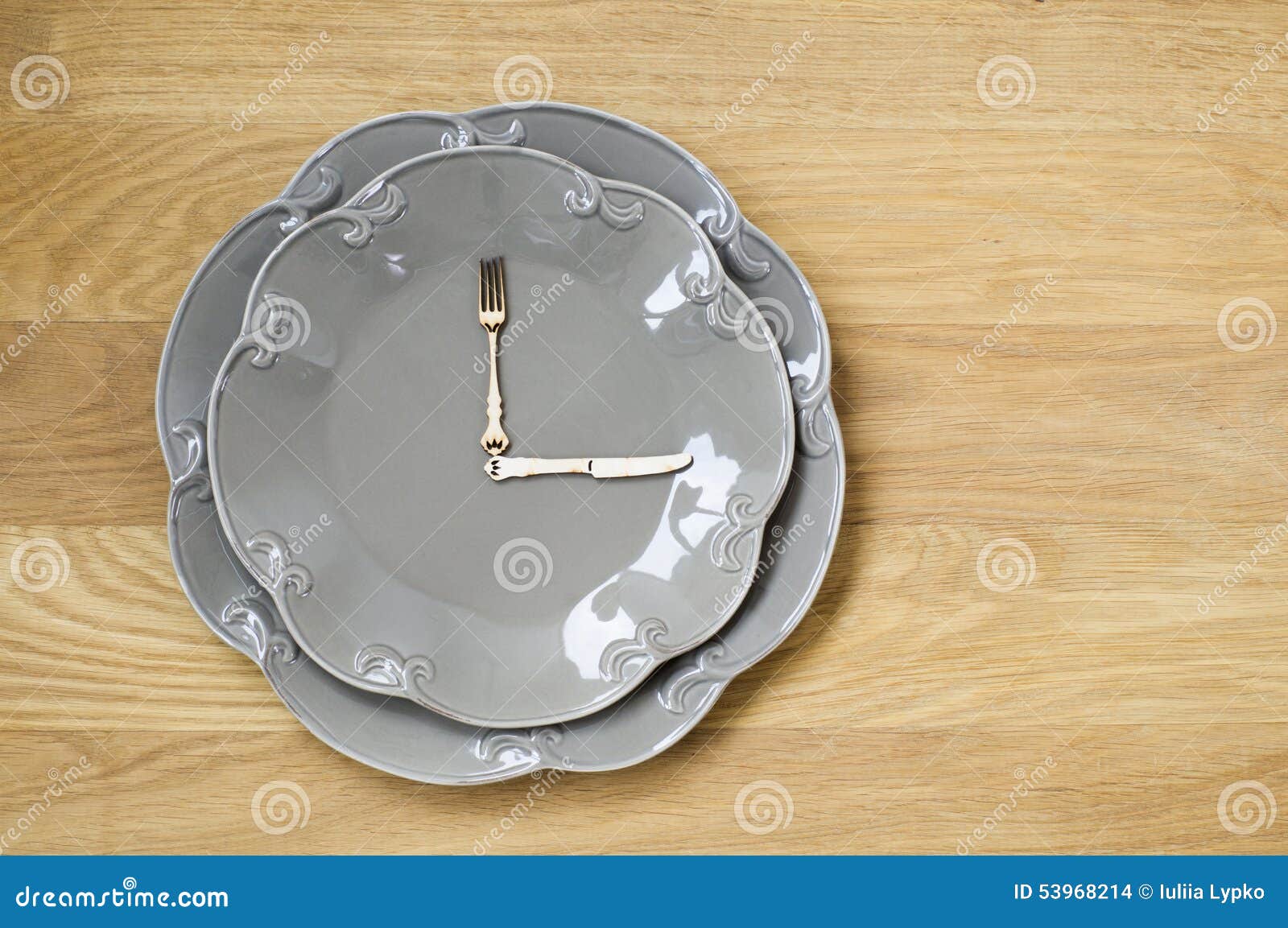 Grey Plate Clock on a Wooden Background Stock Photo - Image of ...