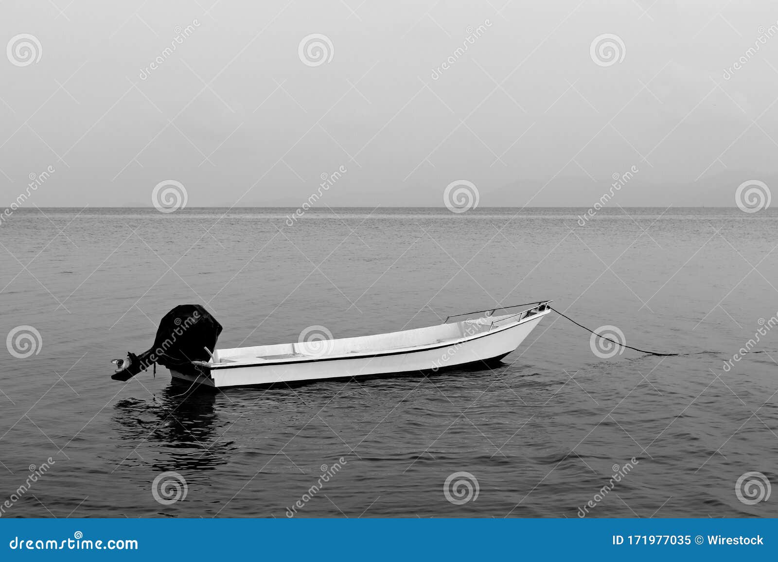 Grey Scale Shot of an Empty Motorboat on the Calm Surface of the Water ...