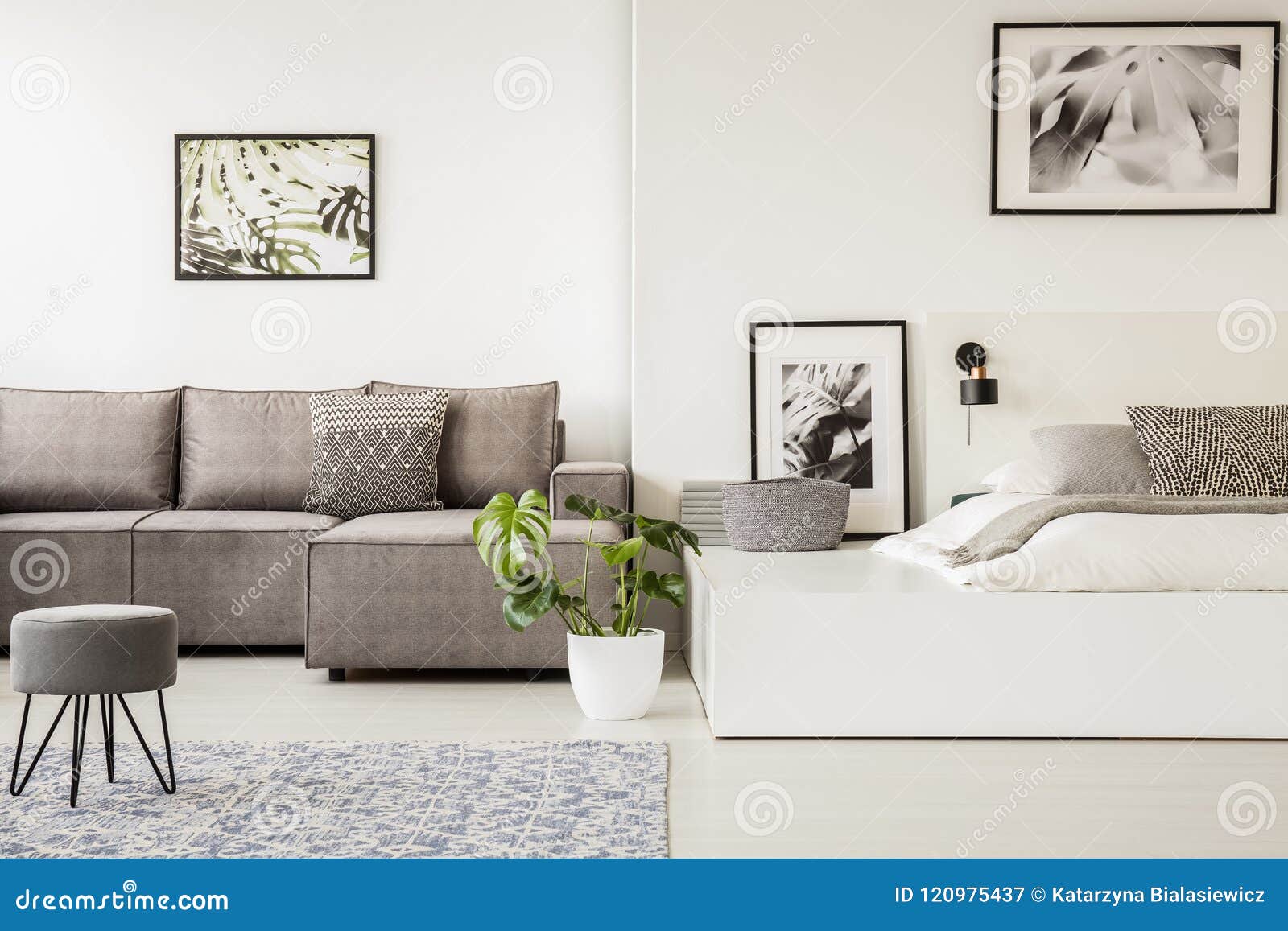 Grey Stool in Front of a Corner Sofa in Open Space Interior with Stock ...