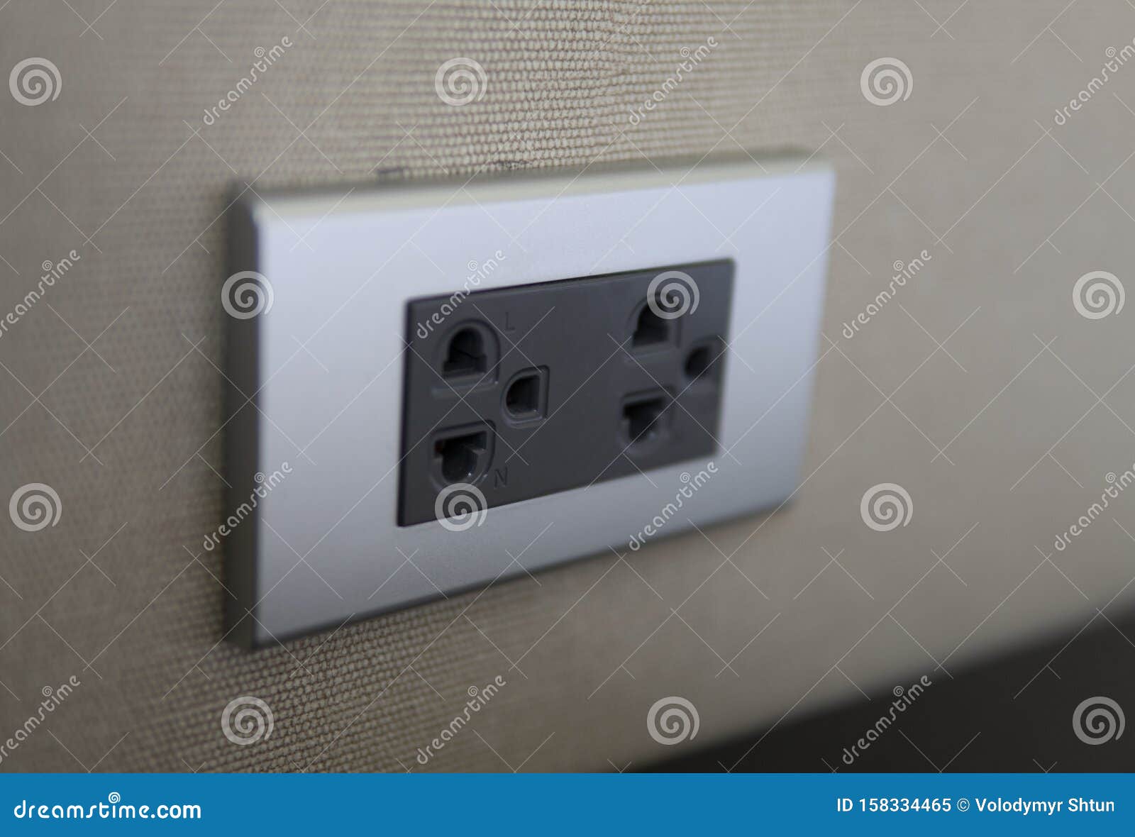 Grey Universal Electricity Sockets Plug on a Yellow Wall. Stock Image ...