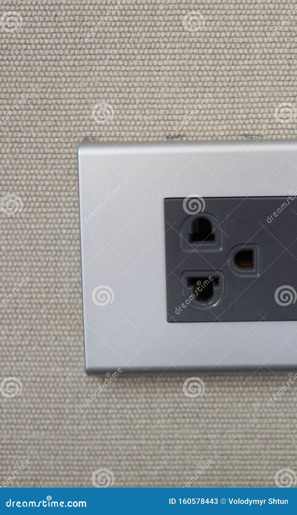 Grey Universal Electricity Sockets Plug on a Yellow Wall. Stock Image ...